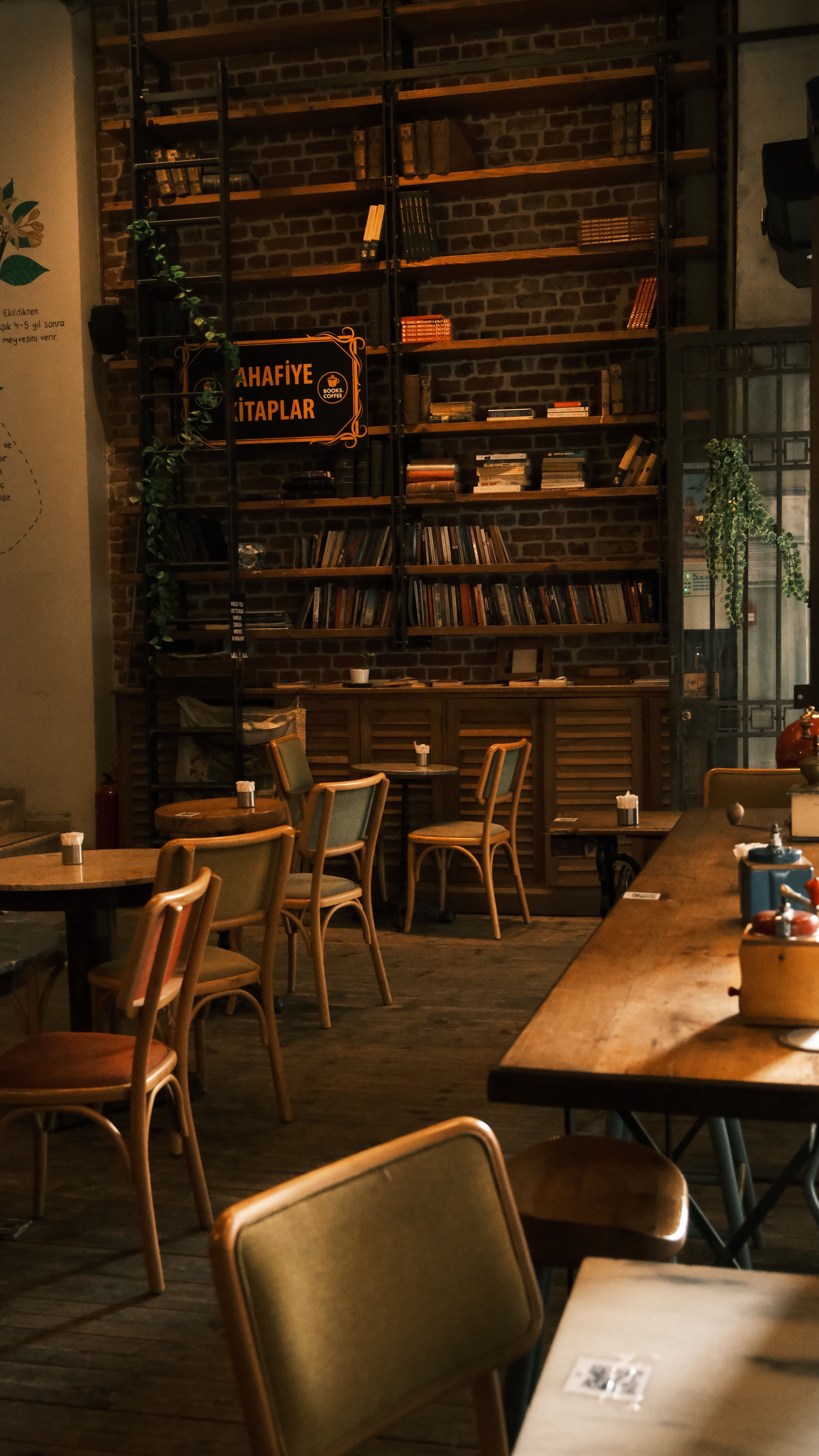 Cozy Vintage Cafe Interior with Bookshelf · Free Stock Photo