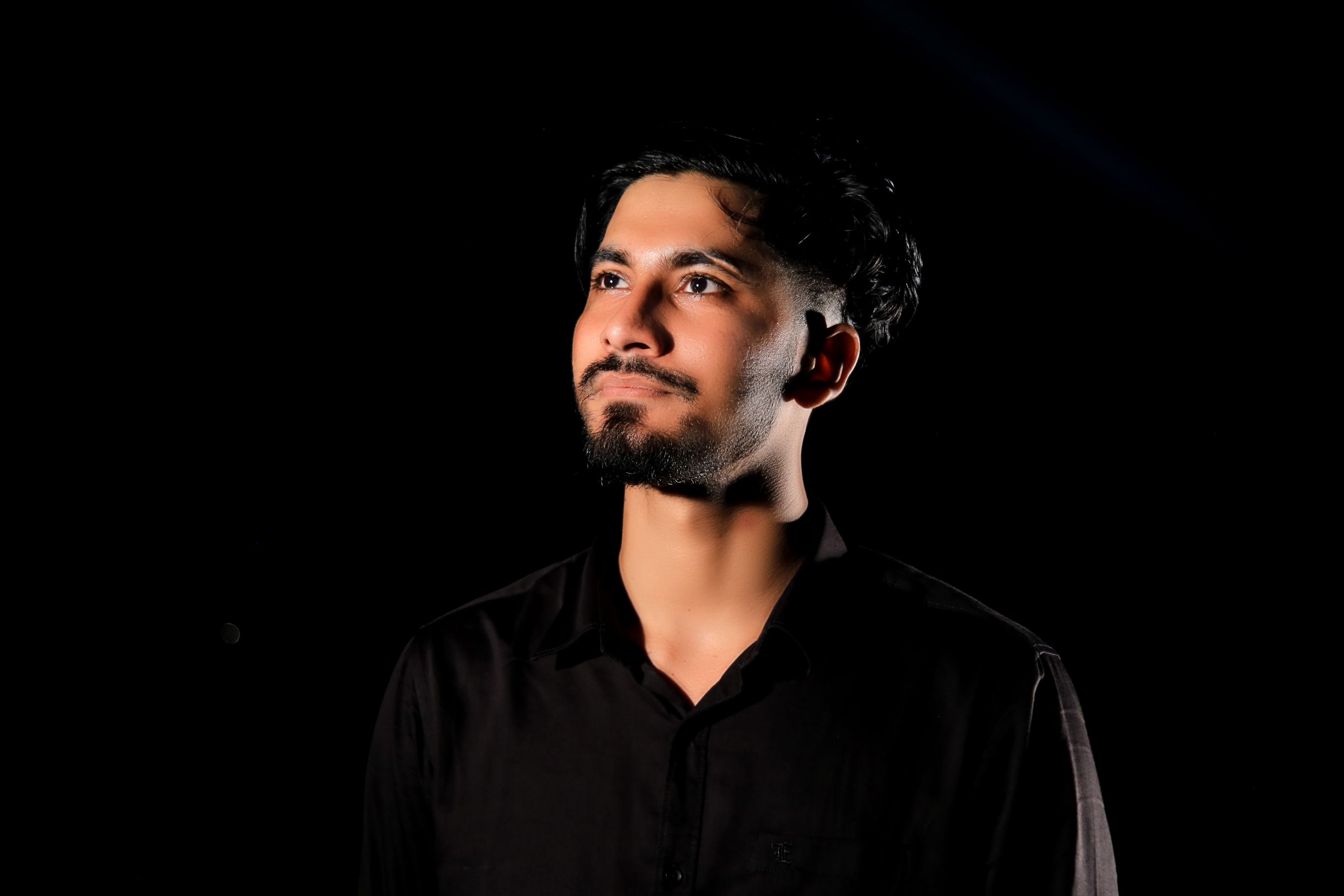 Thoughtful Young Man in Dramatic Lighting · Free Stock Photo