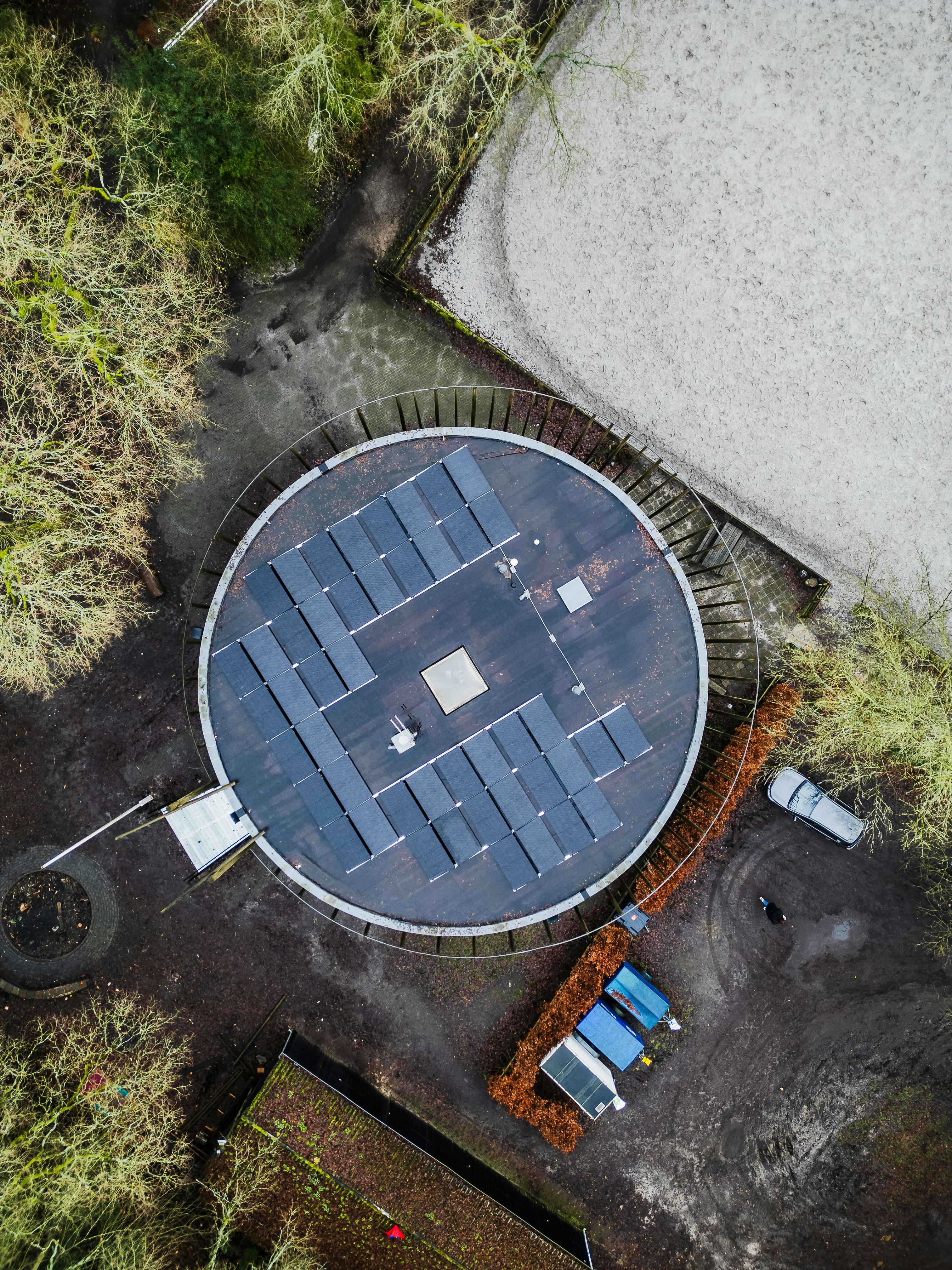 Aerial View of Circular Rooftop with Solar Panels · Free Stock Photo