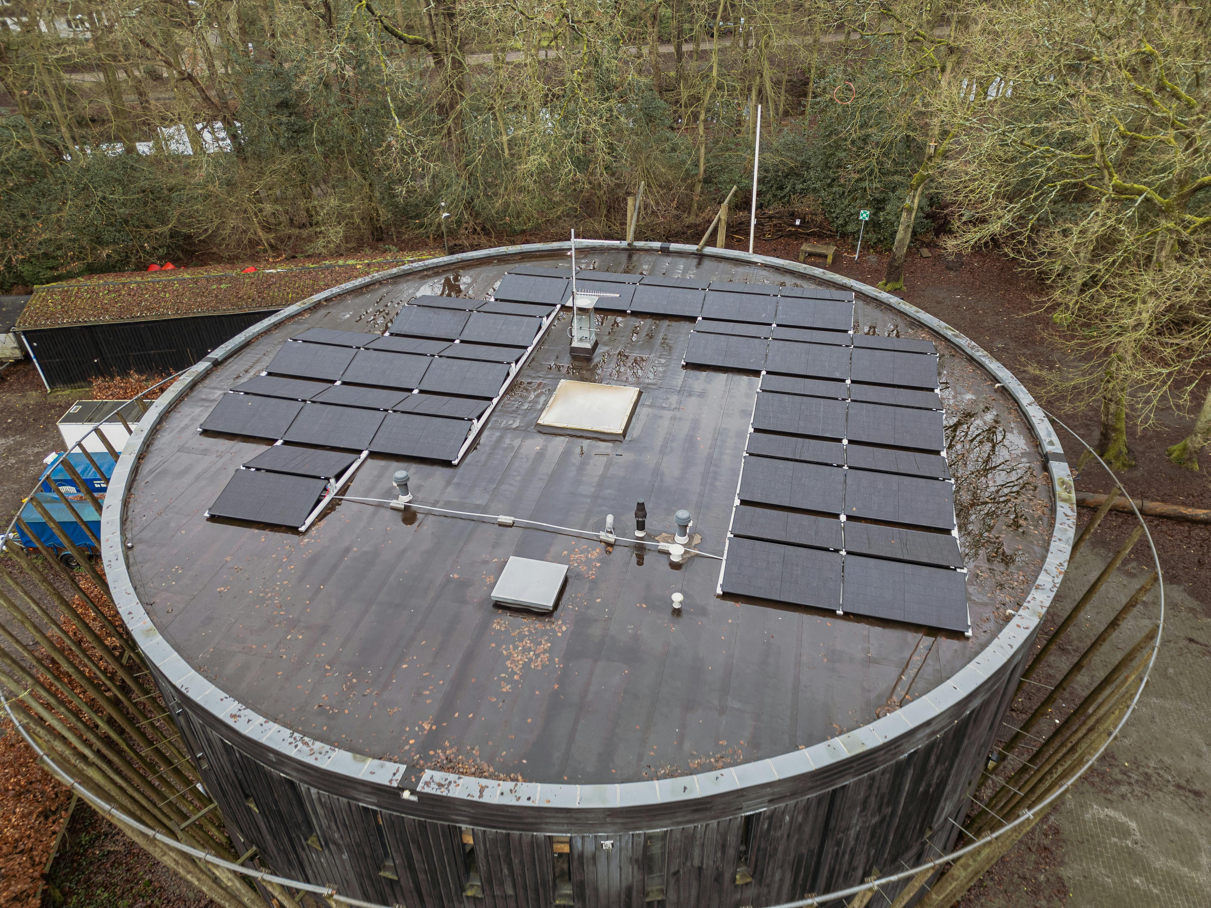 Aerial View of Rooftop Solar Panels on Circular Building · Free Stock Photo