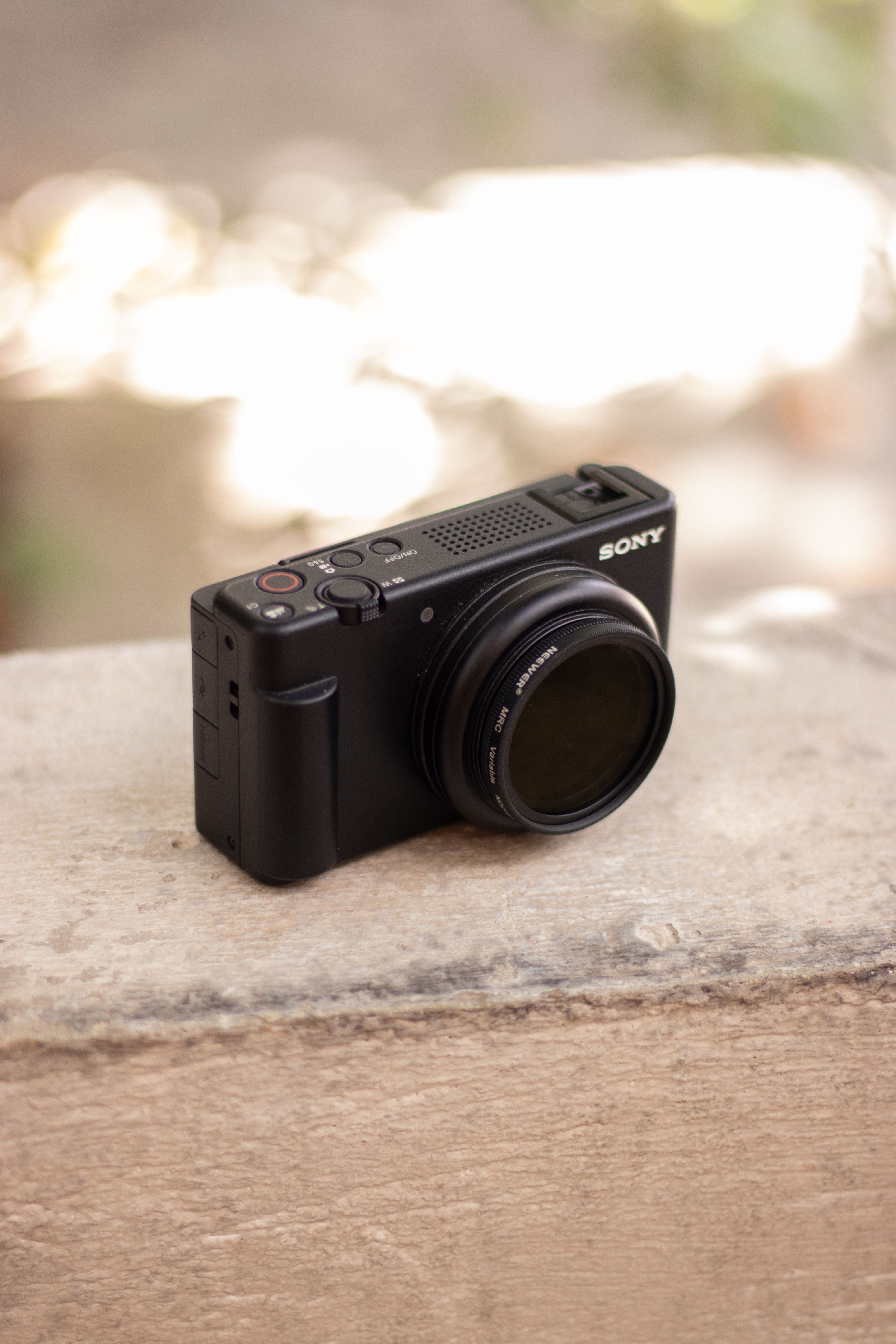 Compact Digital Camera on Stone Surface Outdoors · Free Stock Photo