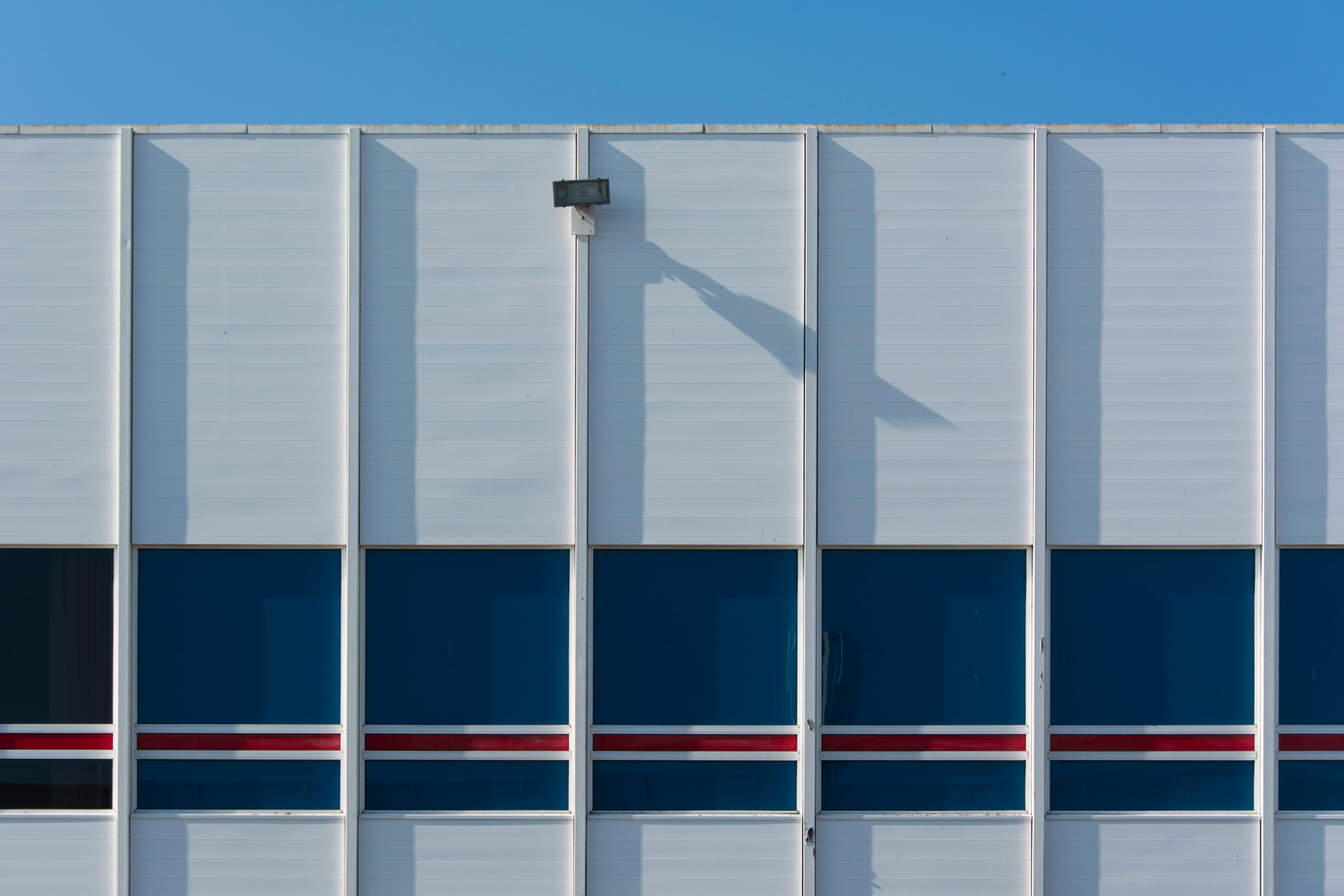 Modern Architectural Facade with Glass Panels · Free Stock Photo