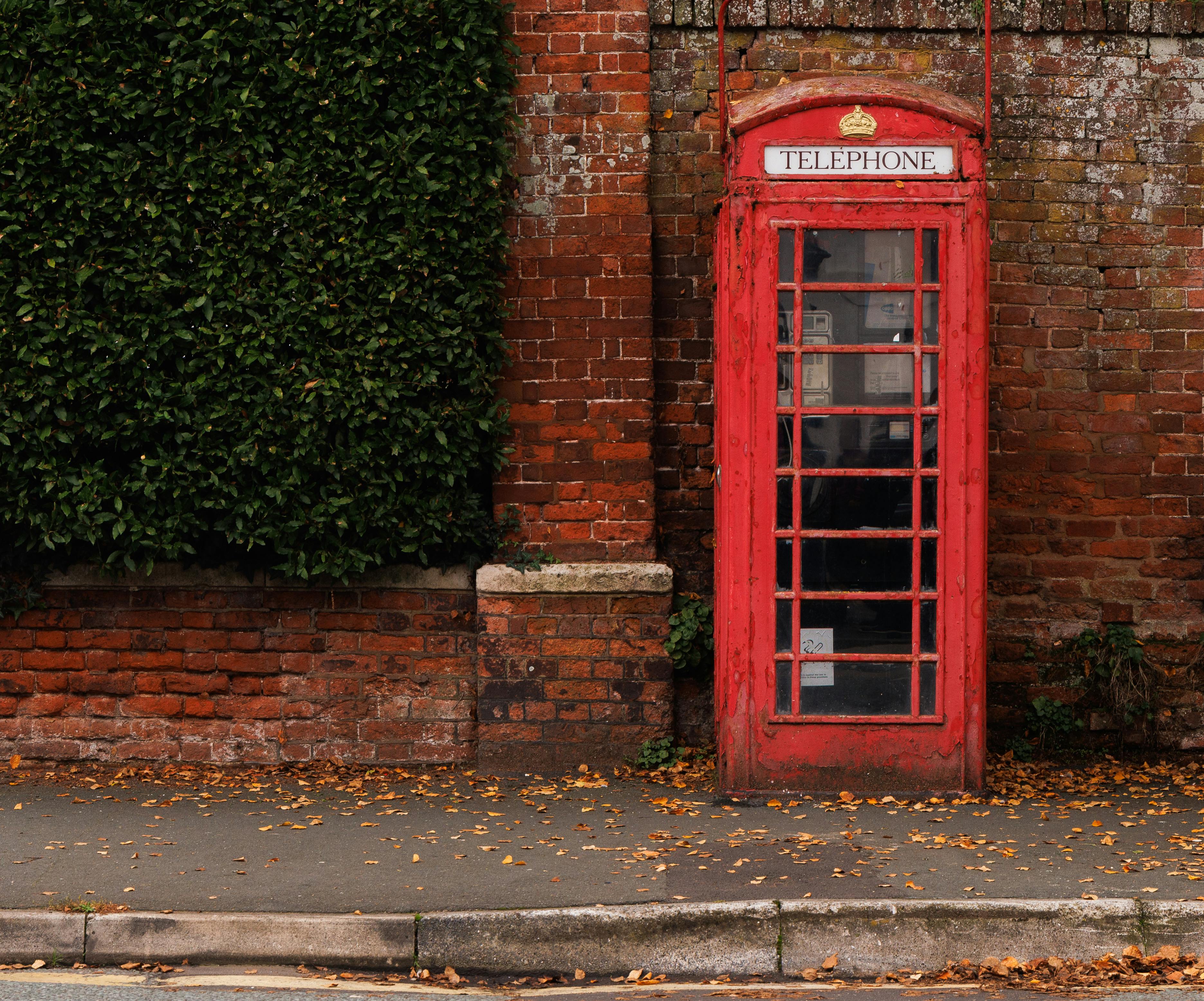 Classic Red British Telephone Booth in Autumn · Free Stock Photo