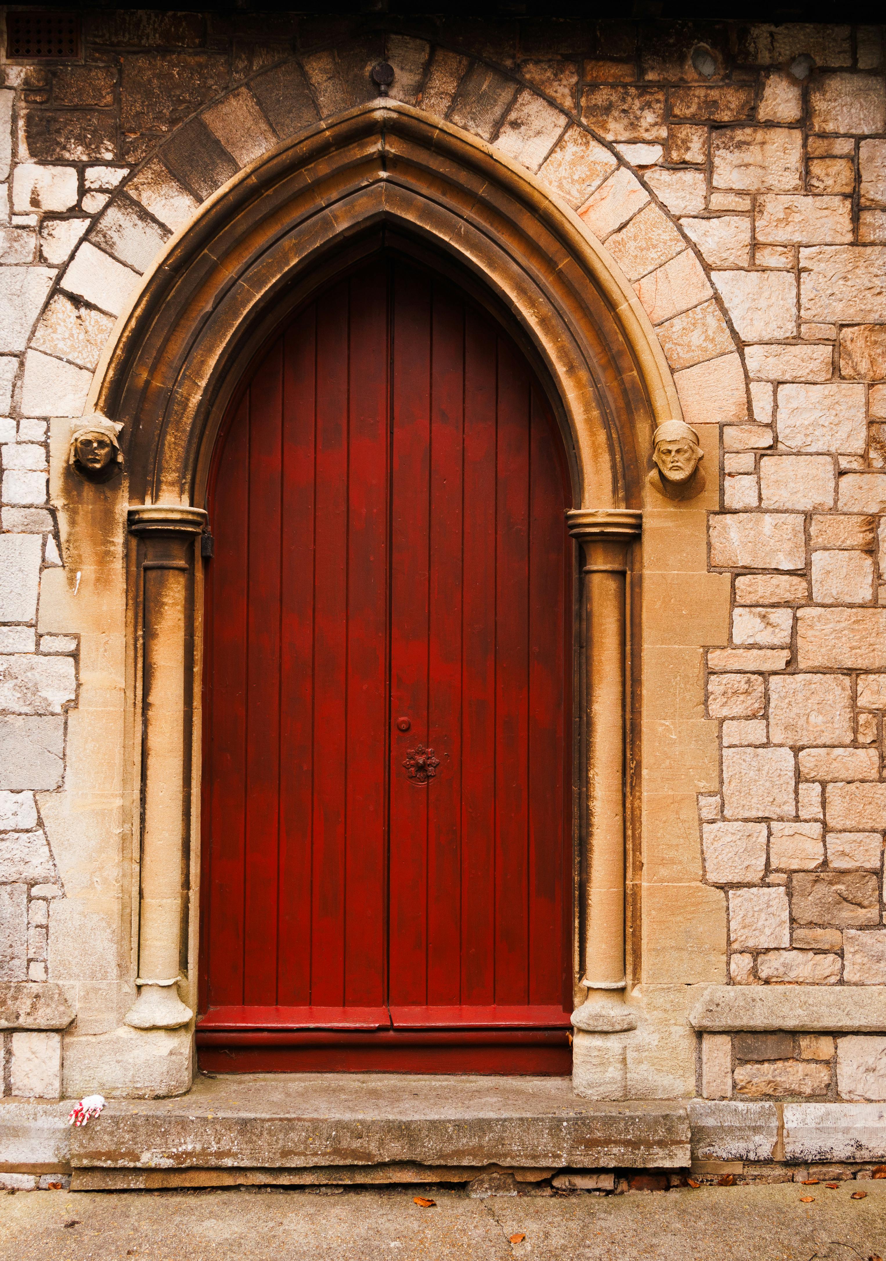 Gothic Red Door in Stone Archway · Free Stock Photo