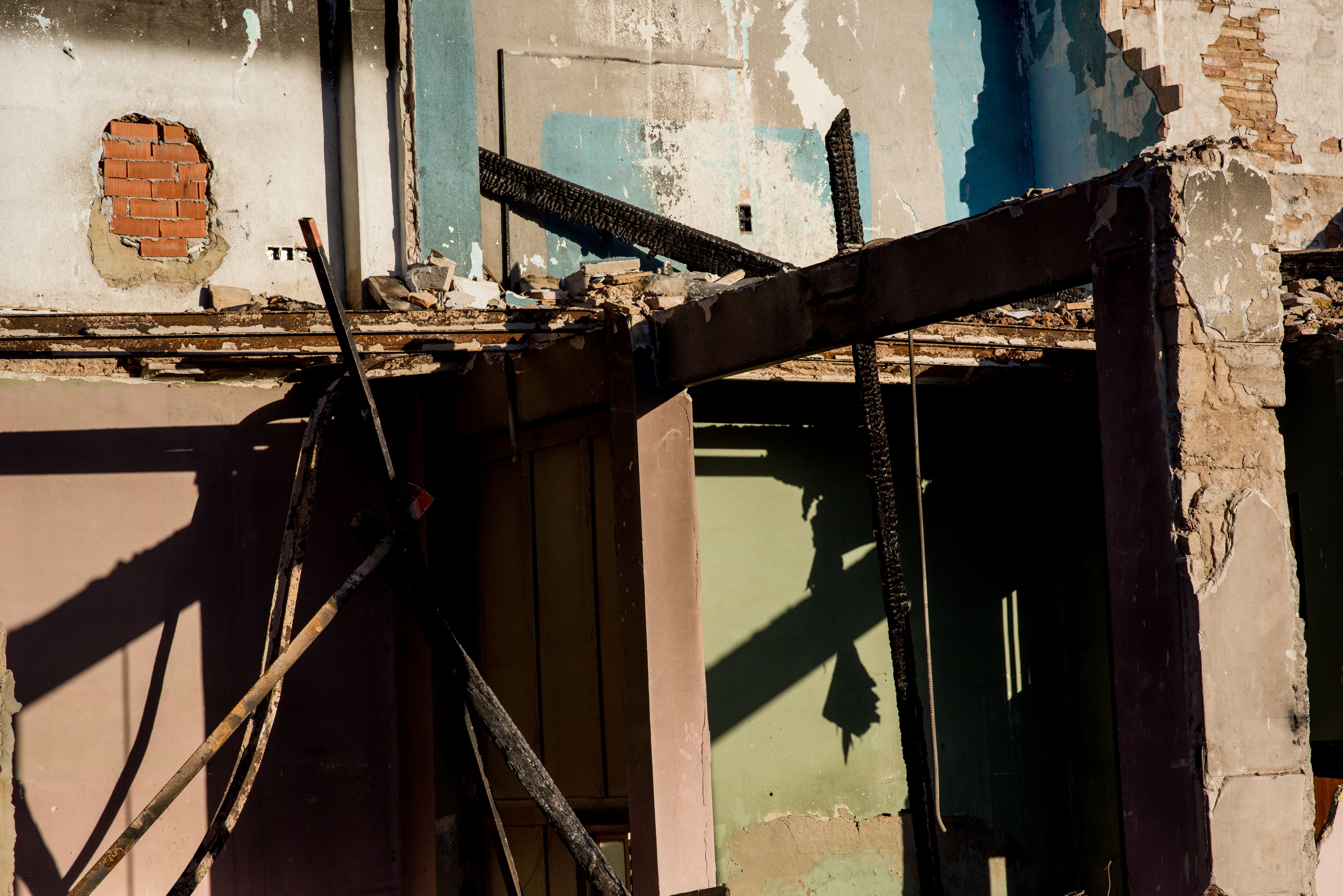 Abandoned Building with Exposed Brick and Shadows · Free Stock Photo