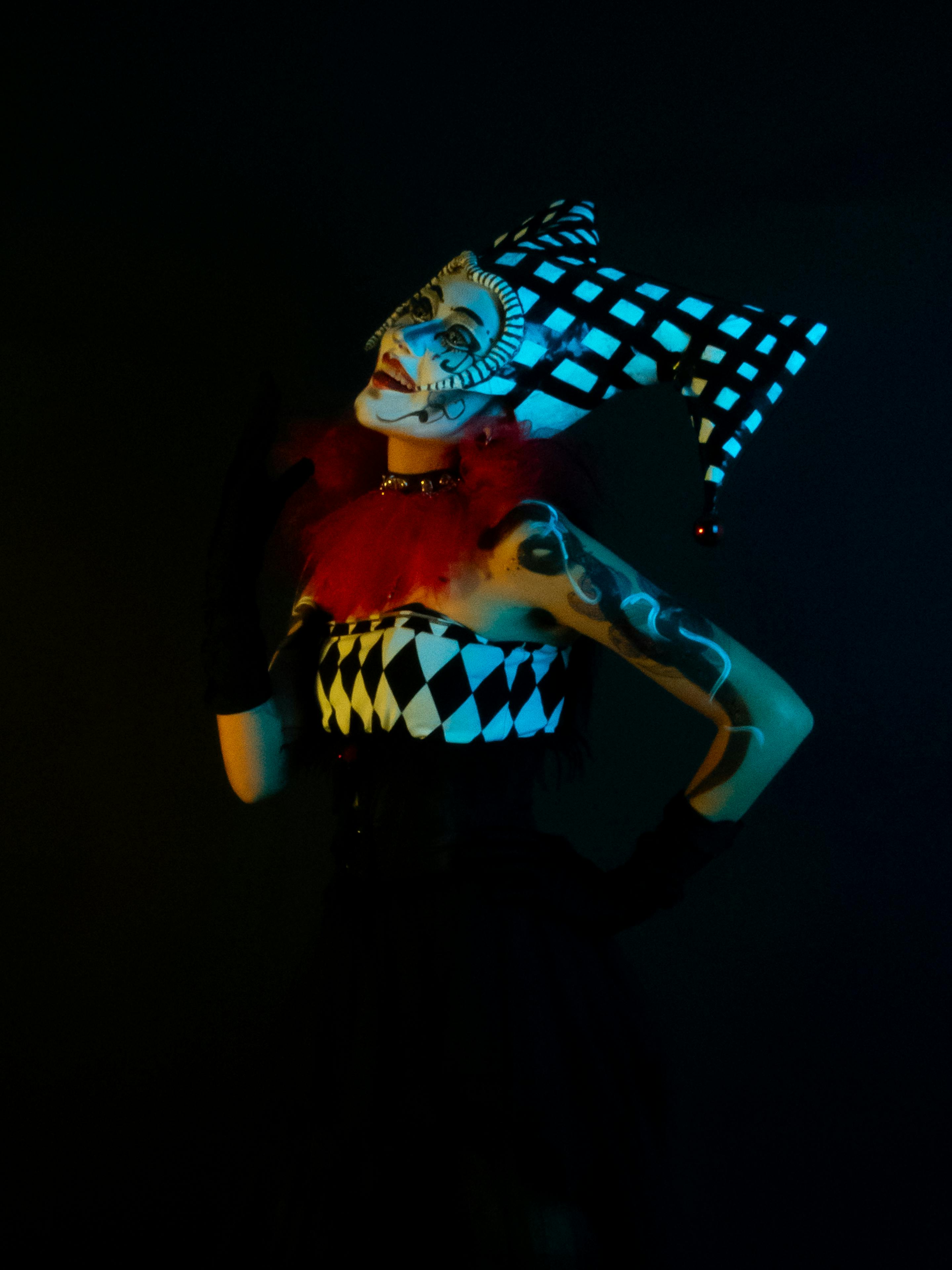 Mysterious Jester in Dramatic Lighting Costume · Free Stock Photo