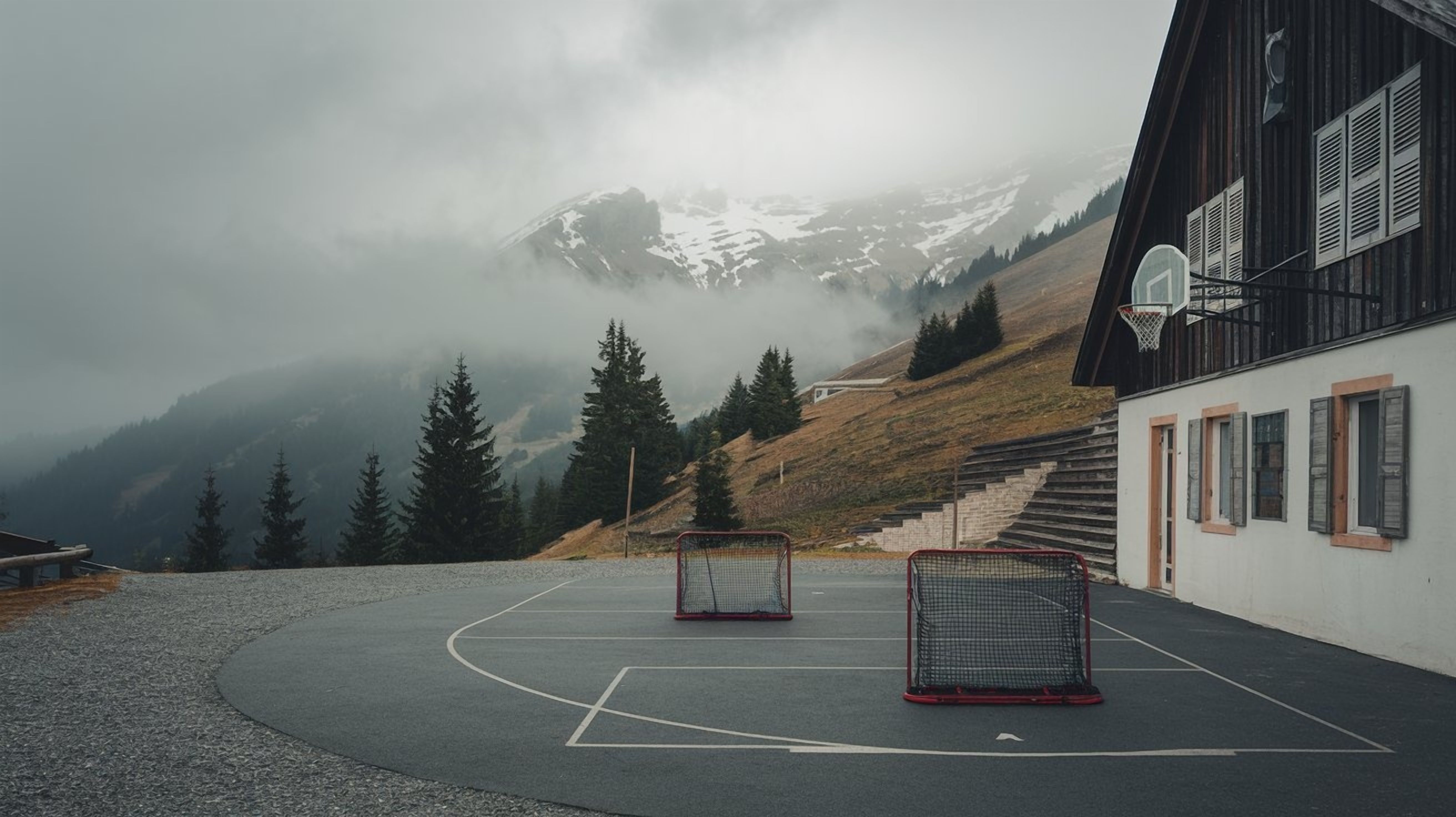 Foggy Mountain Basketball Court in Alpine Setting · Free Stock Photo