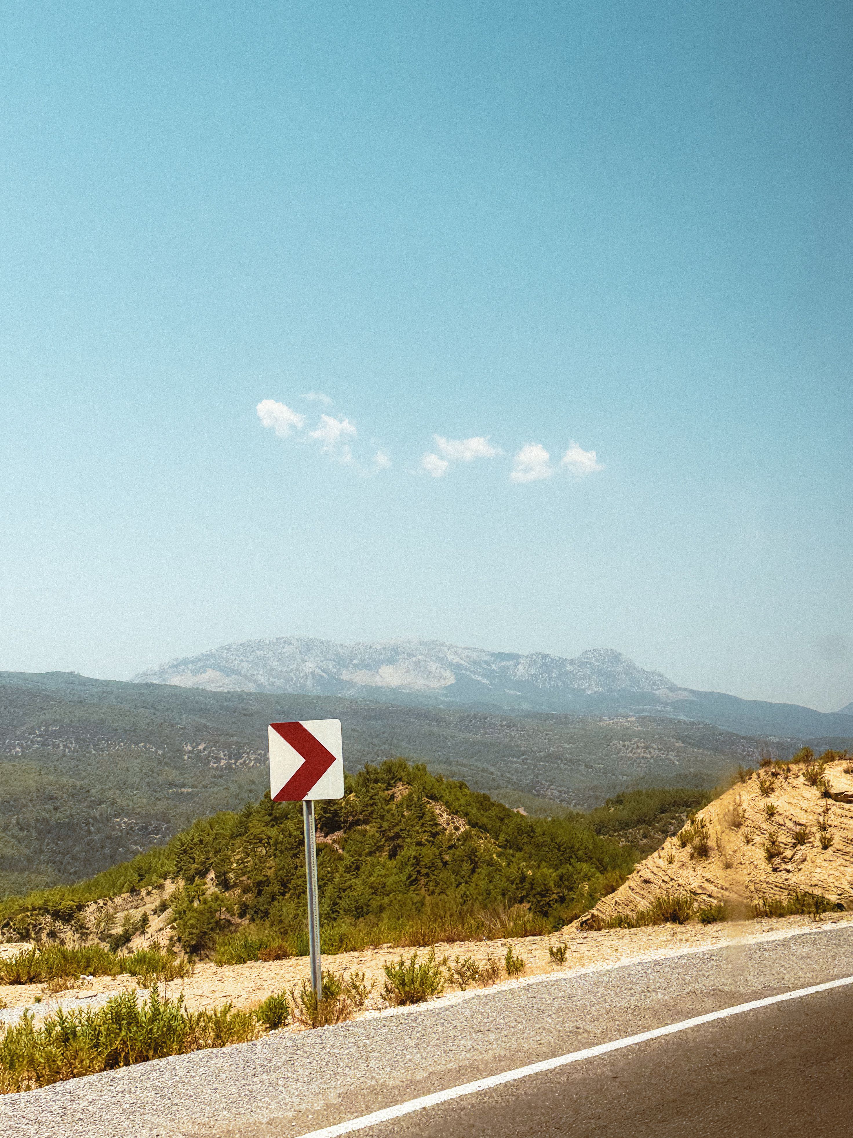 Scenic Mountain Road with Curve Sign · Free Stock Photo