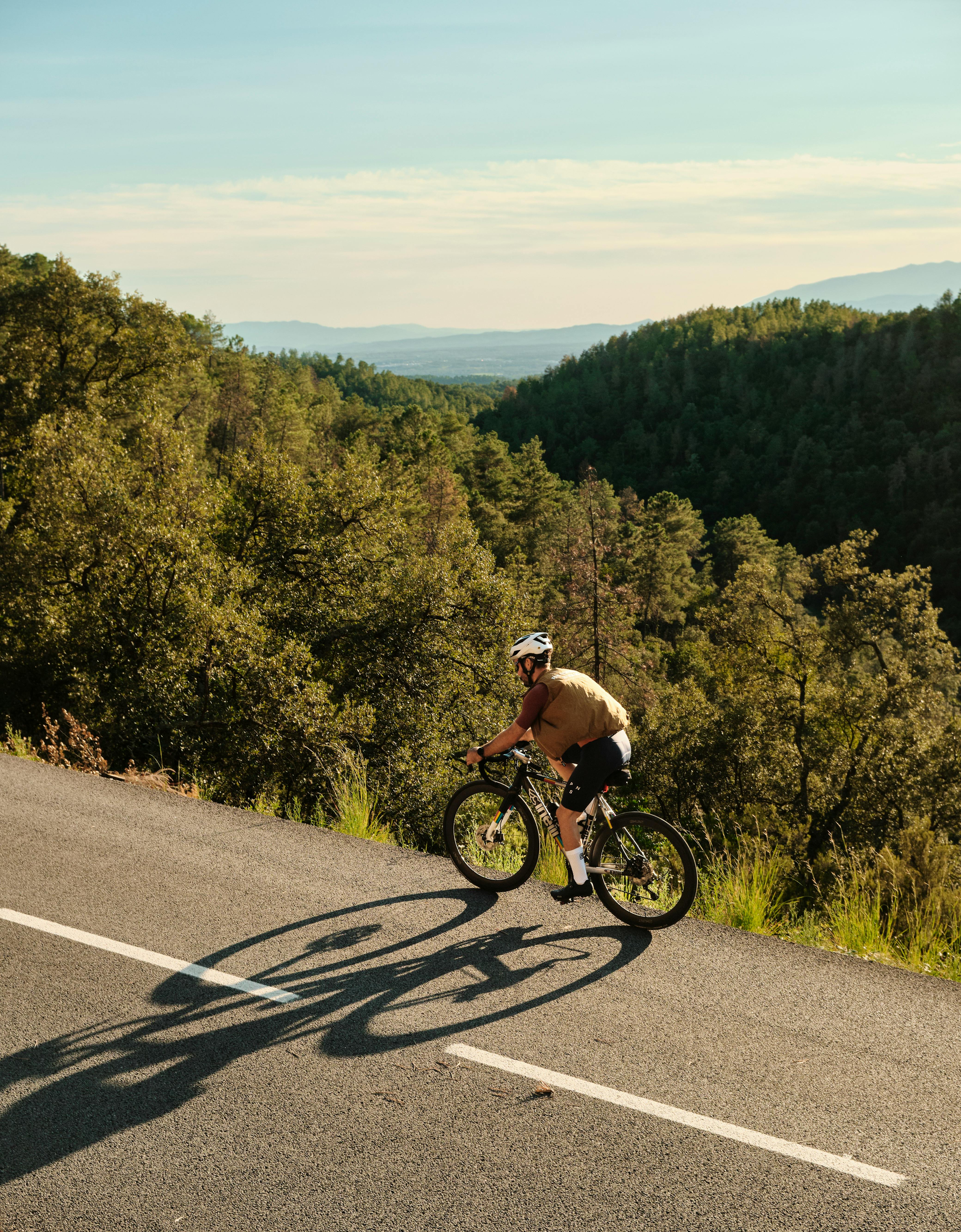 Cyclist Riding on Scenic Mountain Road in Girona · Free Stock Photo