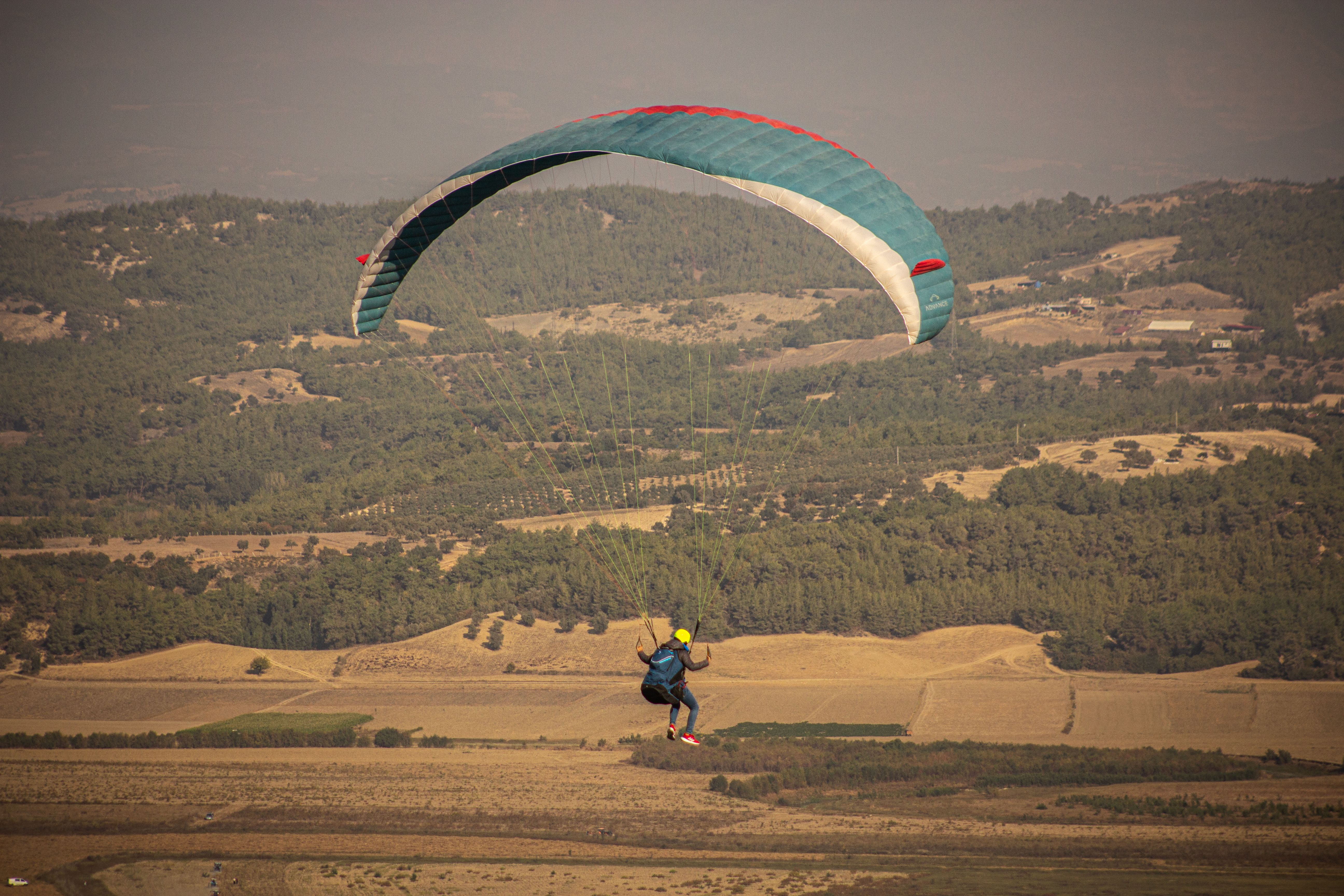 Paragliding Adventure Over Mediterranean Landscape · Free Stock Photo