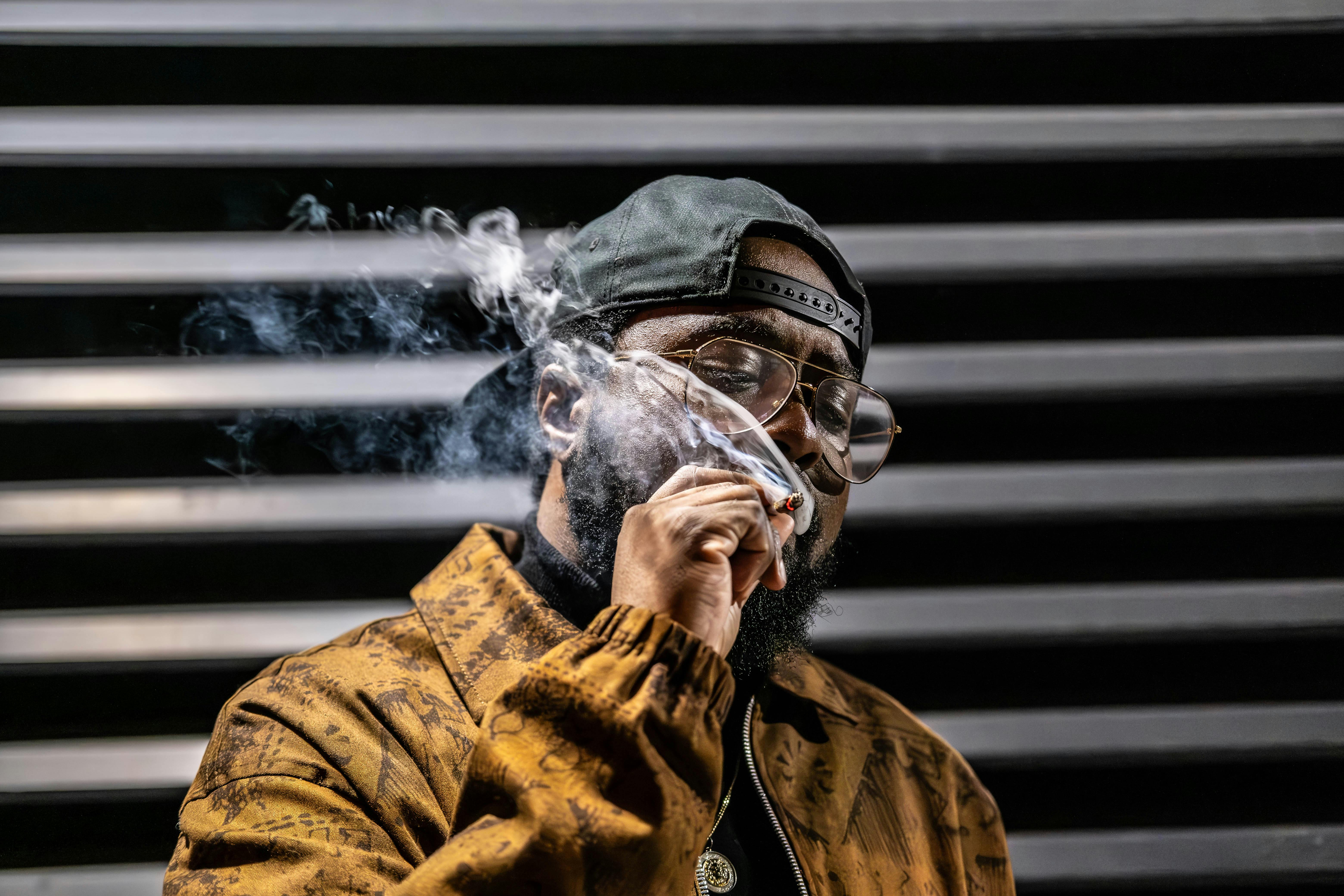 Stylish Urban Portrait of a Man Smoking in Toronto · Free Stock Photo