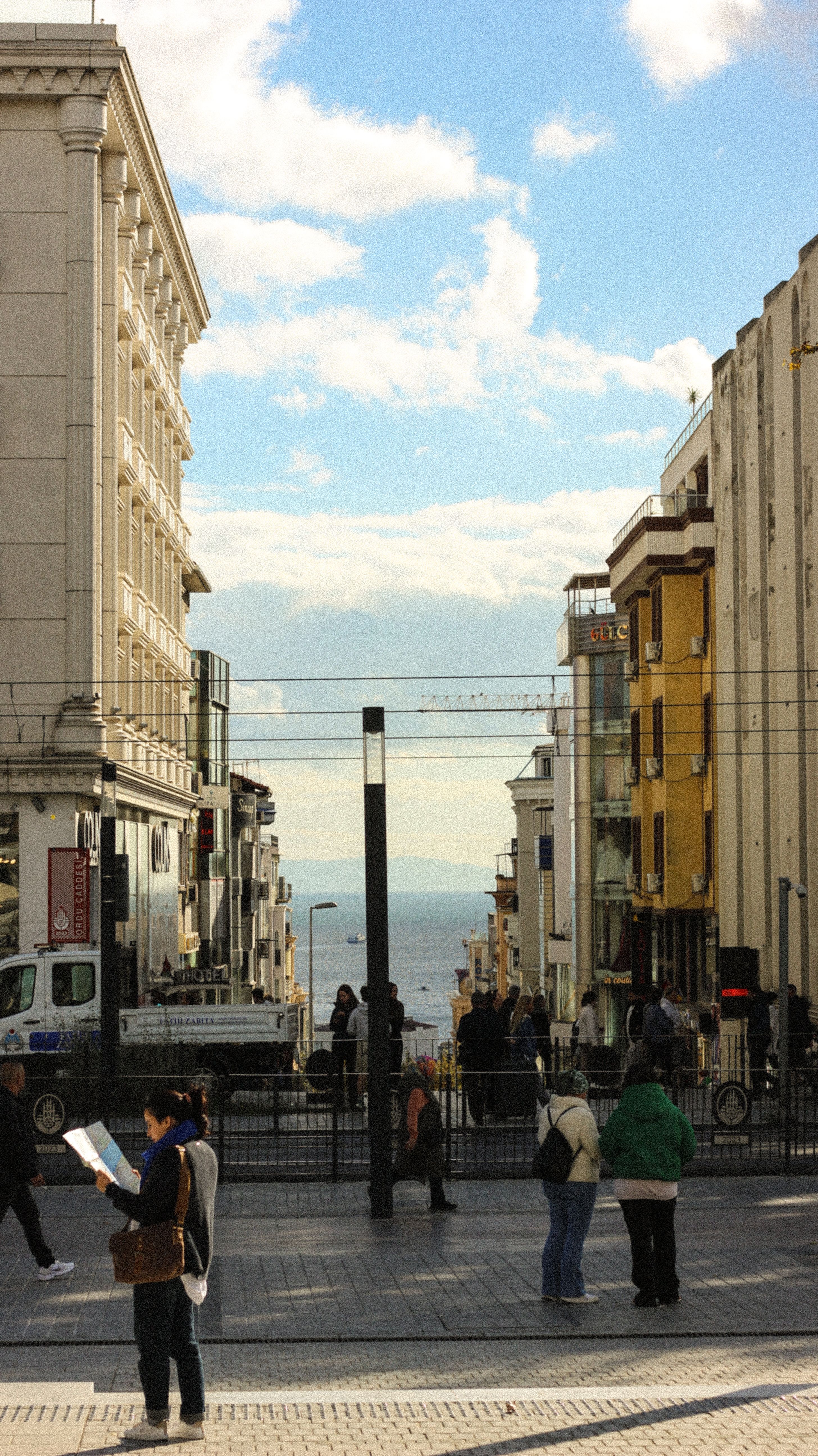 Urban Street View with Pedestrians and Sea Horizon · Free Stock Photo
