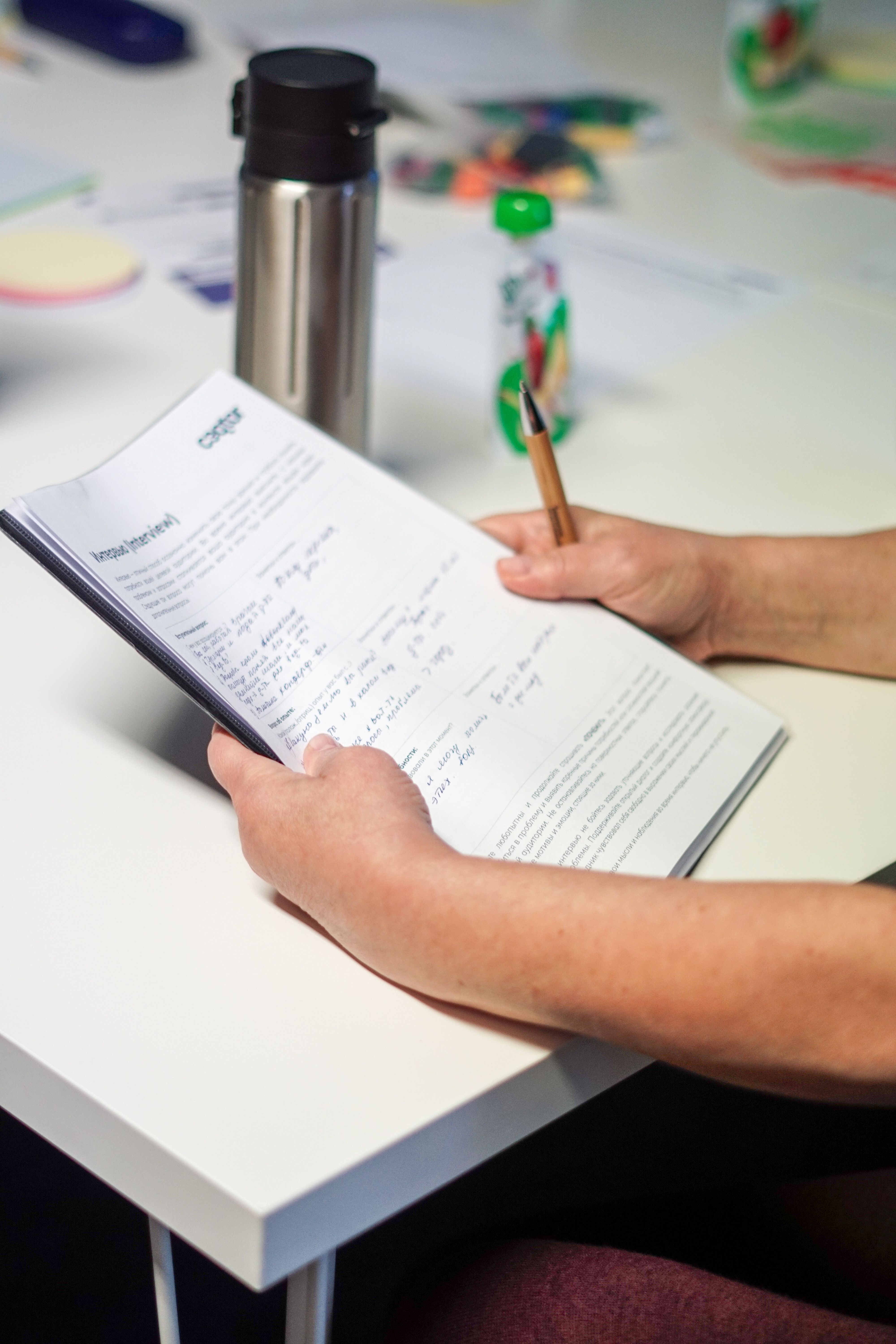 Person reviewing documents at modern office desk · Free Stock Photo