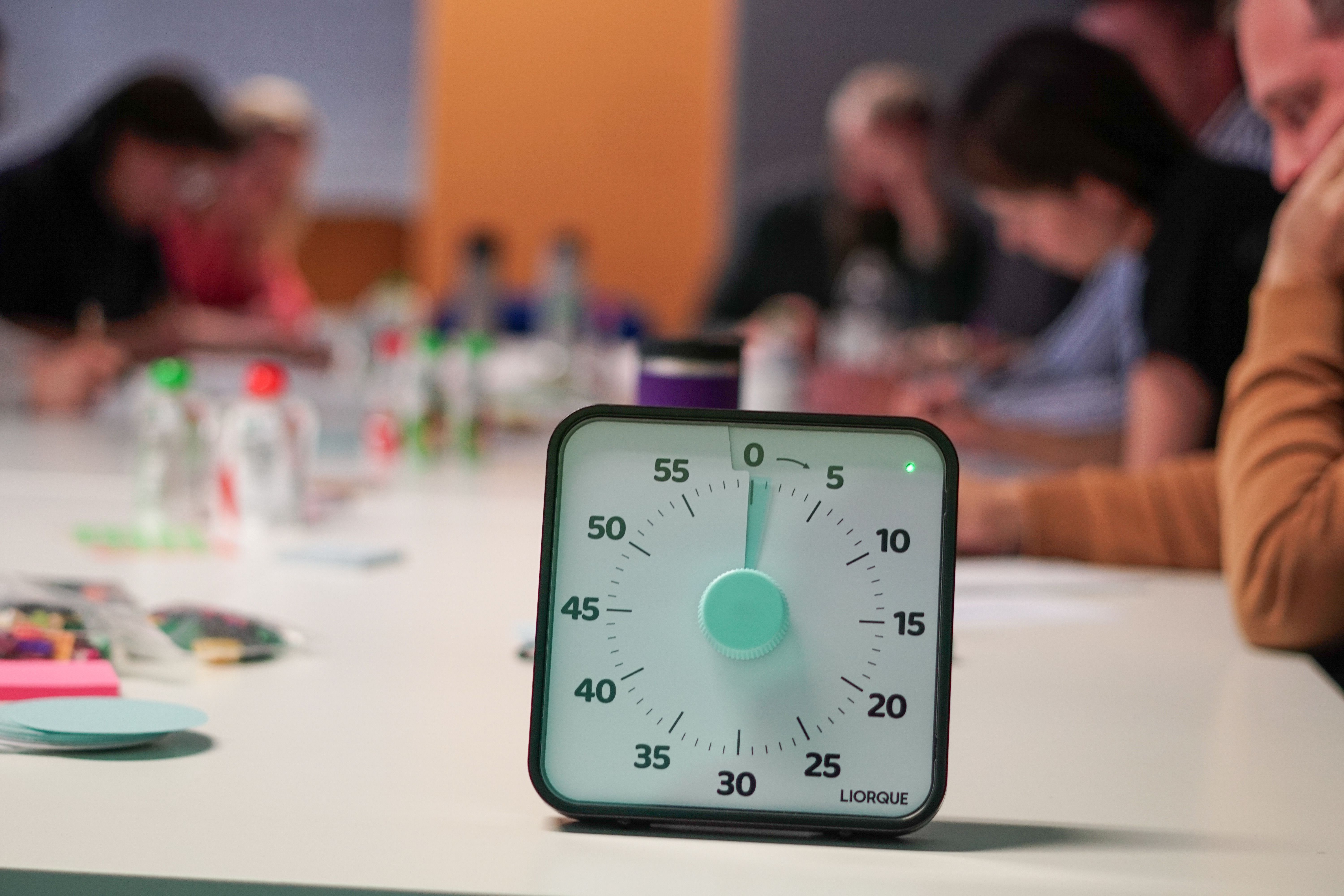 Office Meeting with Focus on a Timer · Free Stock Photo