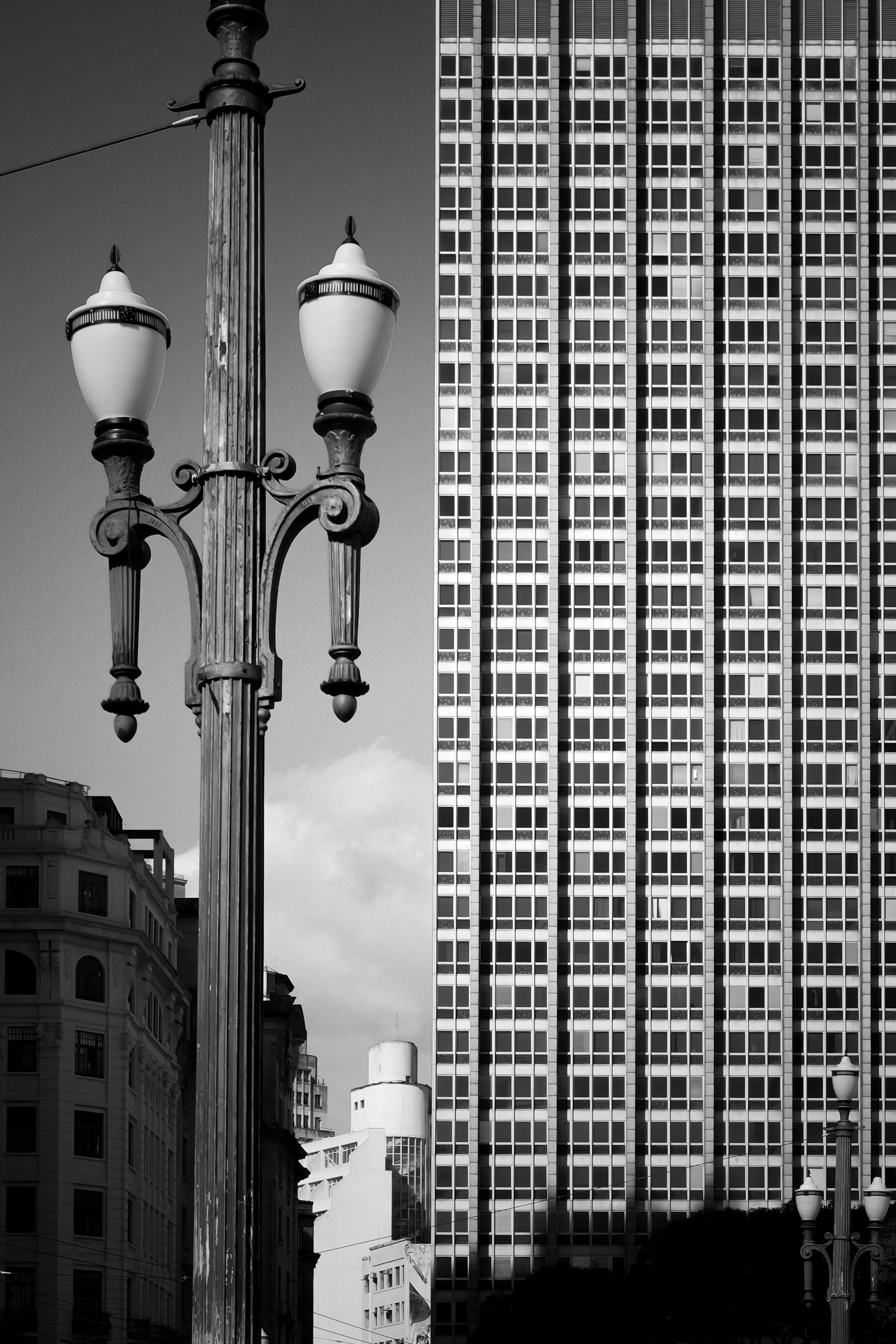 Urban Contrast: Historic Lamppost and Modern Building · Free Stock Photo