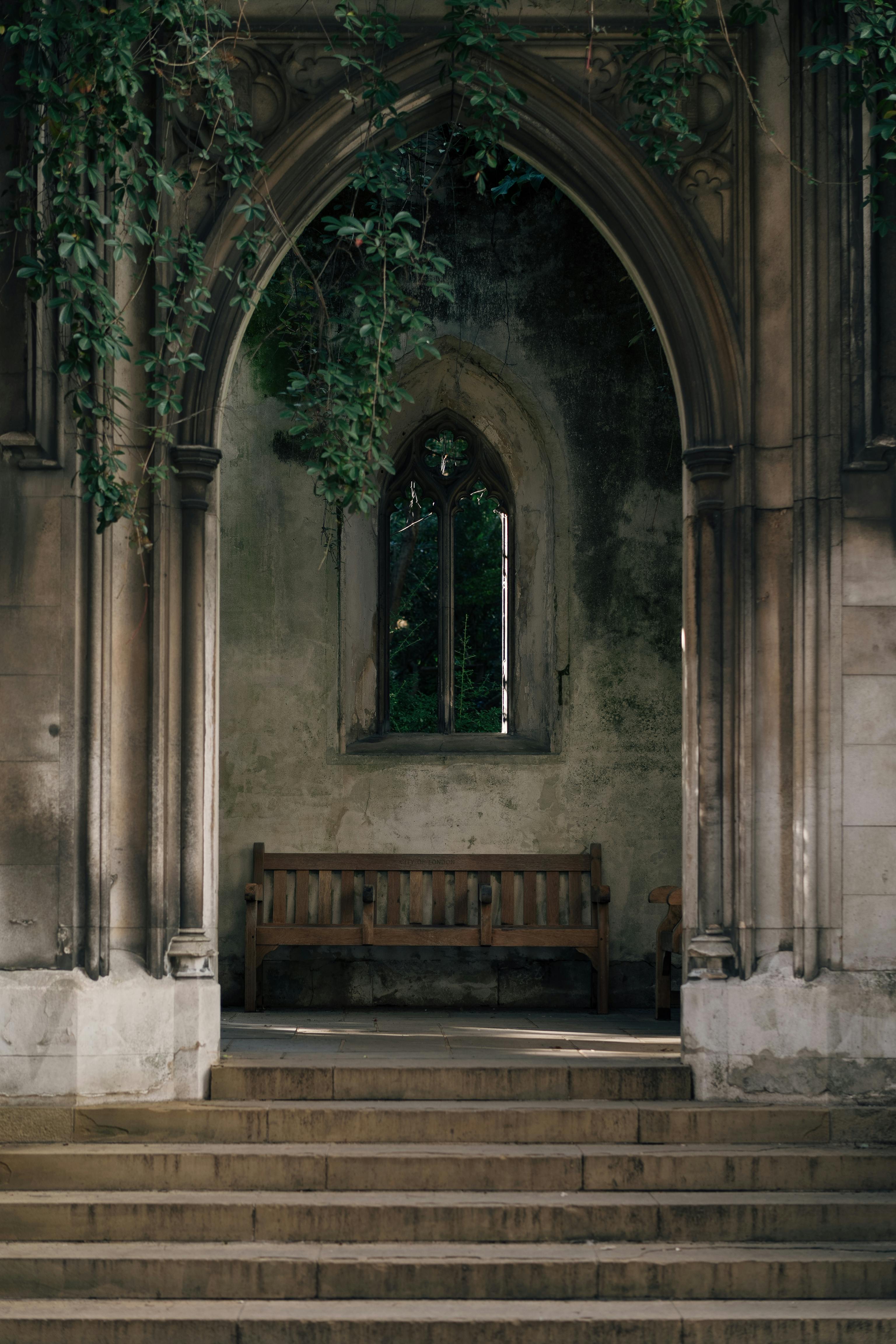 Gothic Archway and Wooden Bench in Ruins · Free Stock Photo