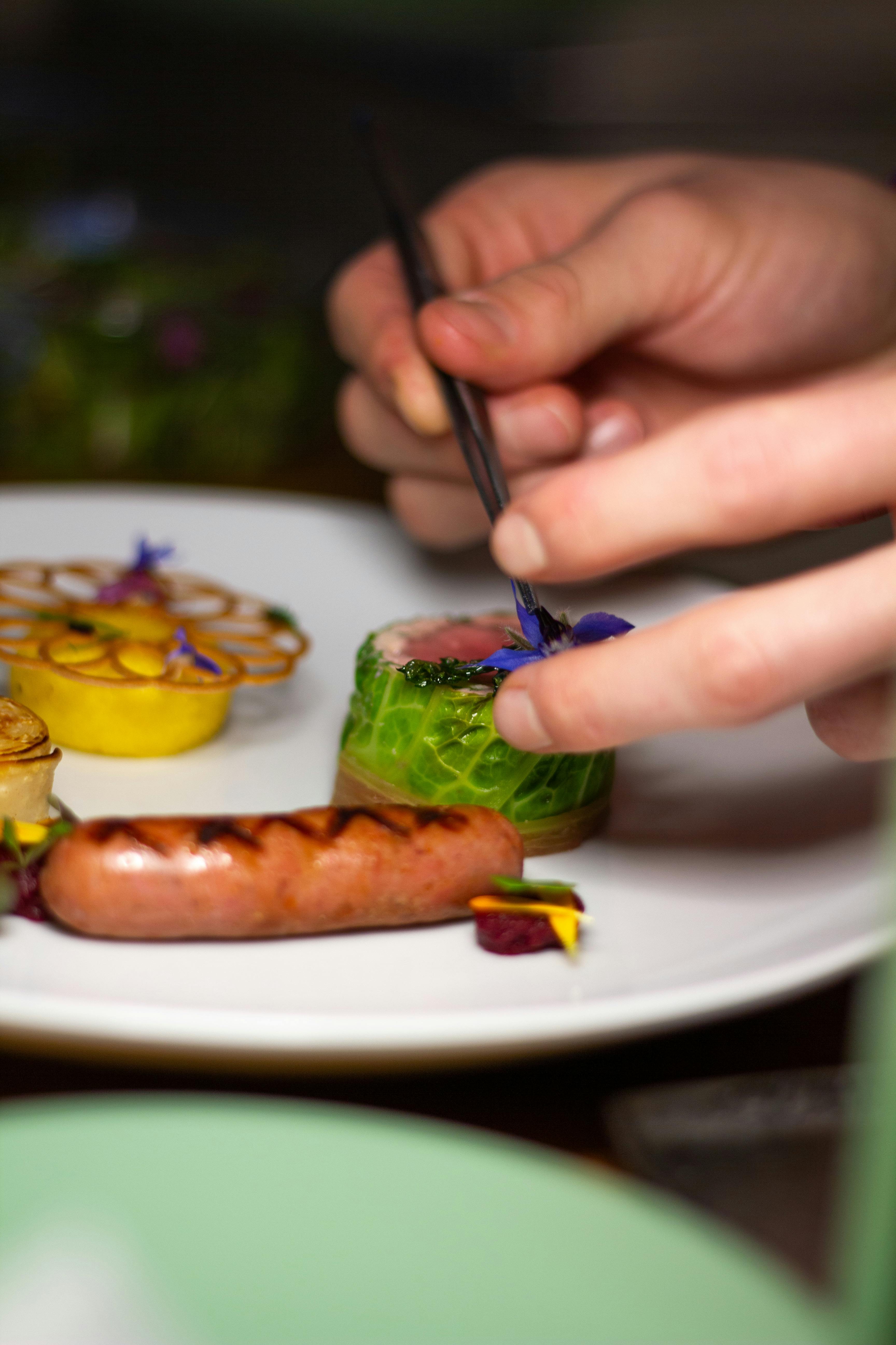 Chef decorating gourmet dish with precision · Free Stock Photo
