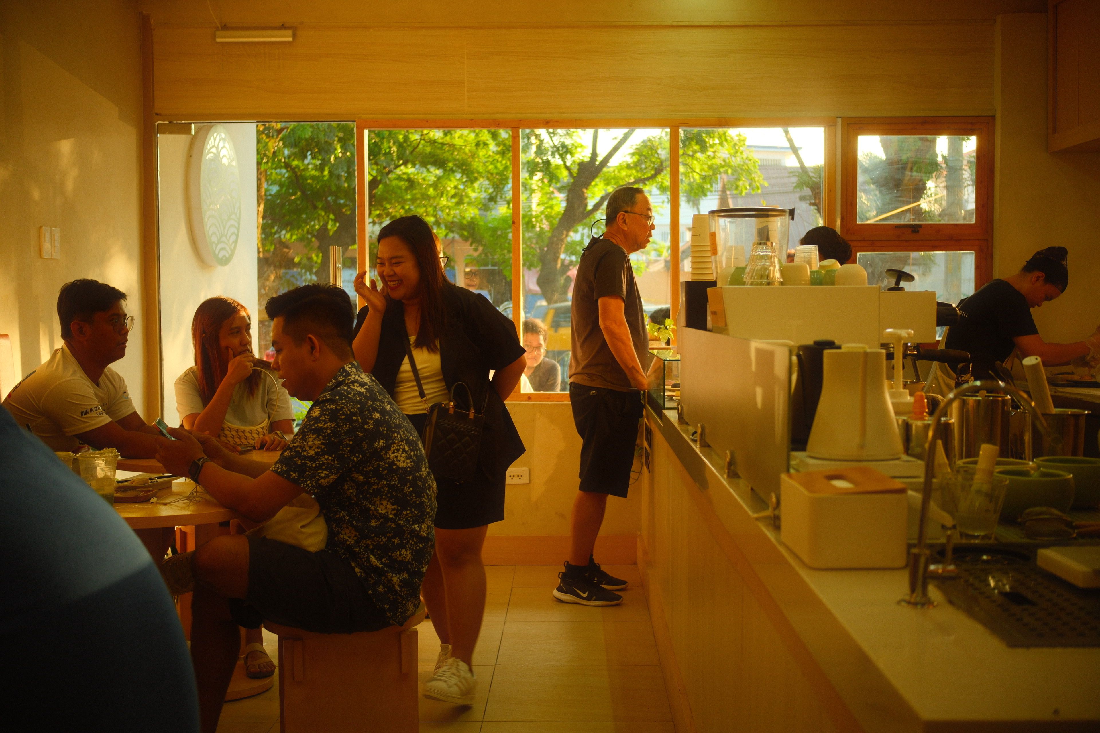 Cozy Café Interior with Customers Relaxing · Free Stock Photo
