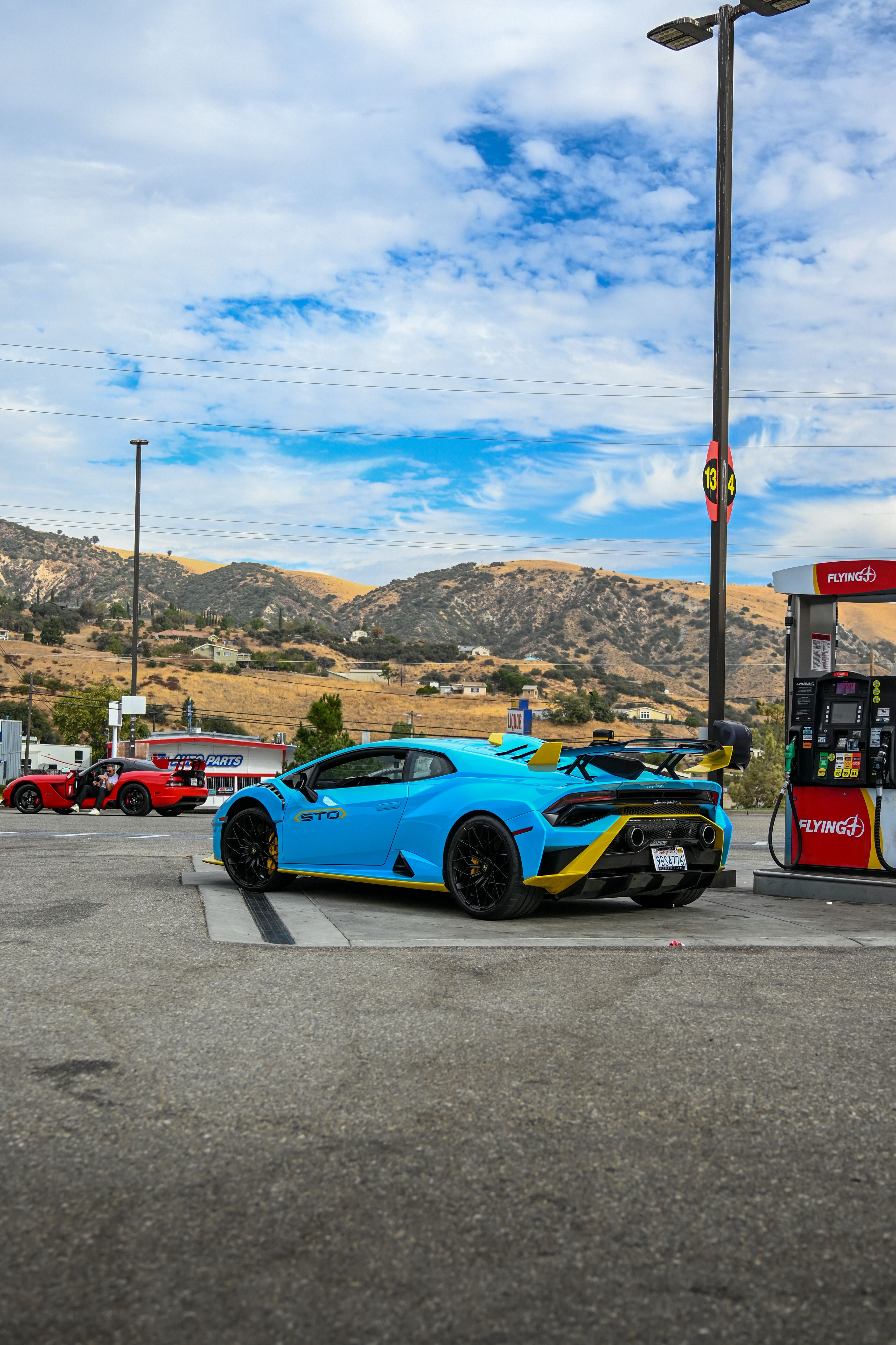 Vibrant Blue Sports Car at Mountain Gas Station · Free Stock Photo
