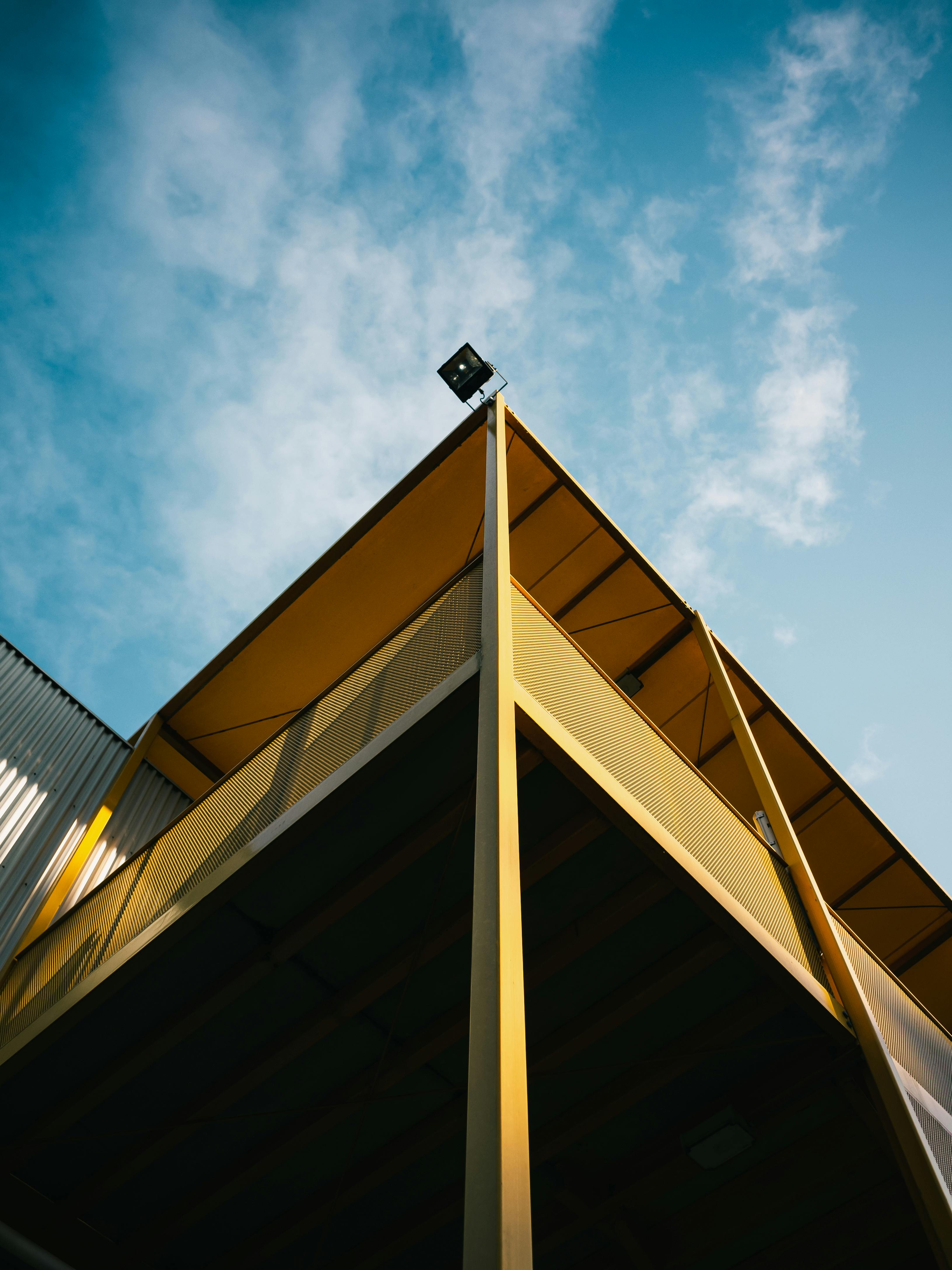 Modern Yellow Building Against Blue Sky · Free Stock Photo