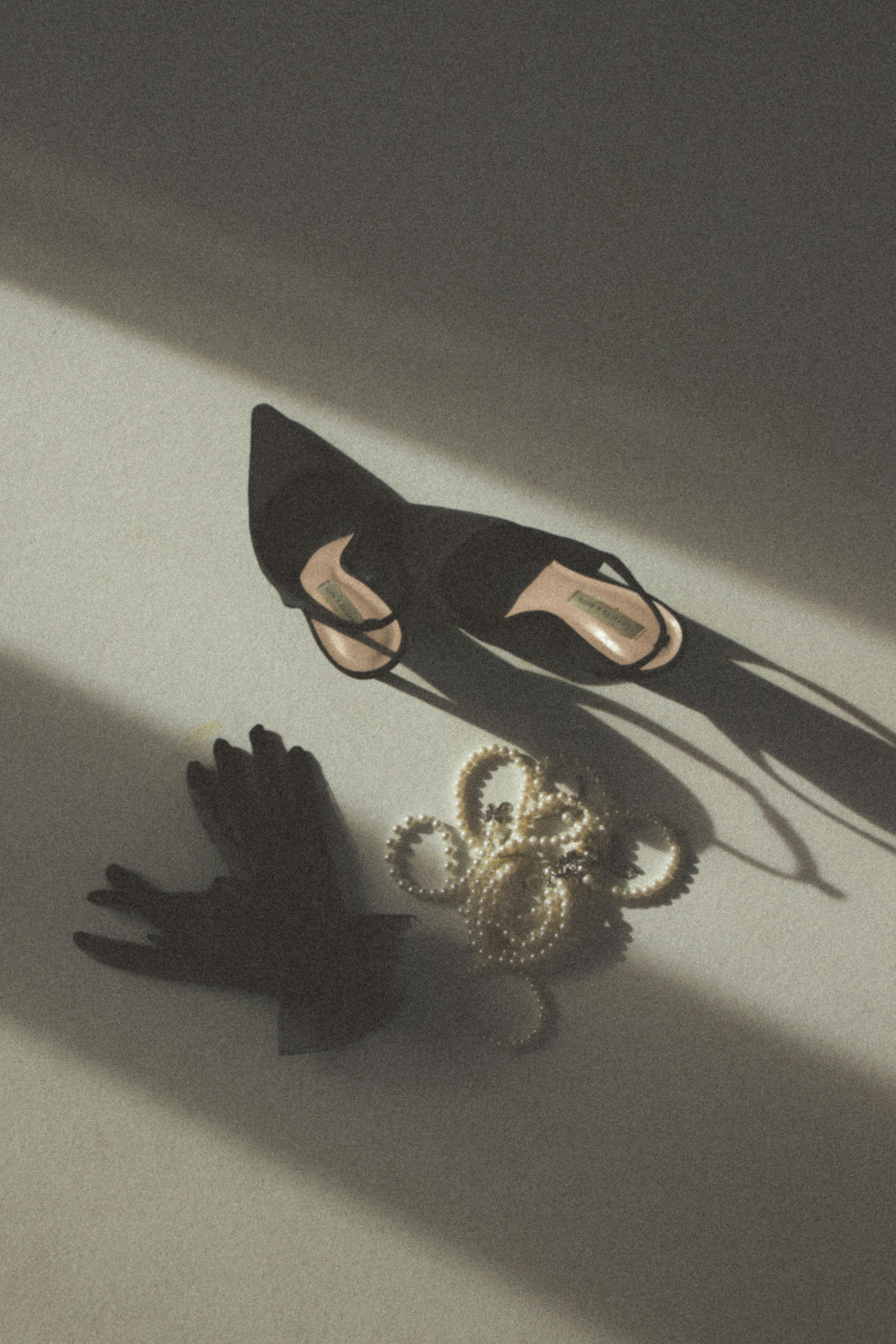 Elegant Black Heels with Pearls and Gloves in Shadow · Free Stock Photo