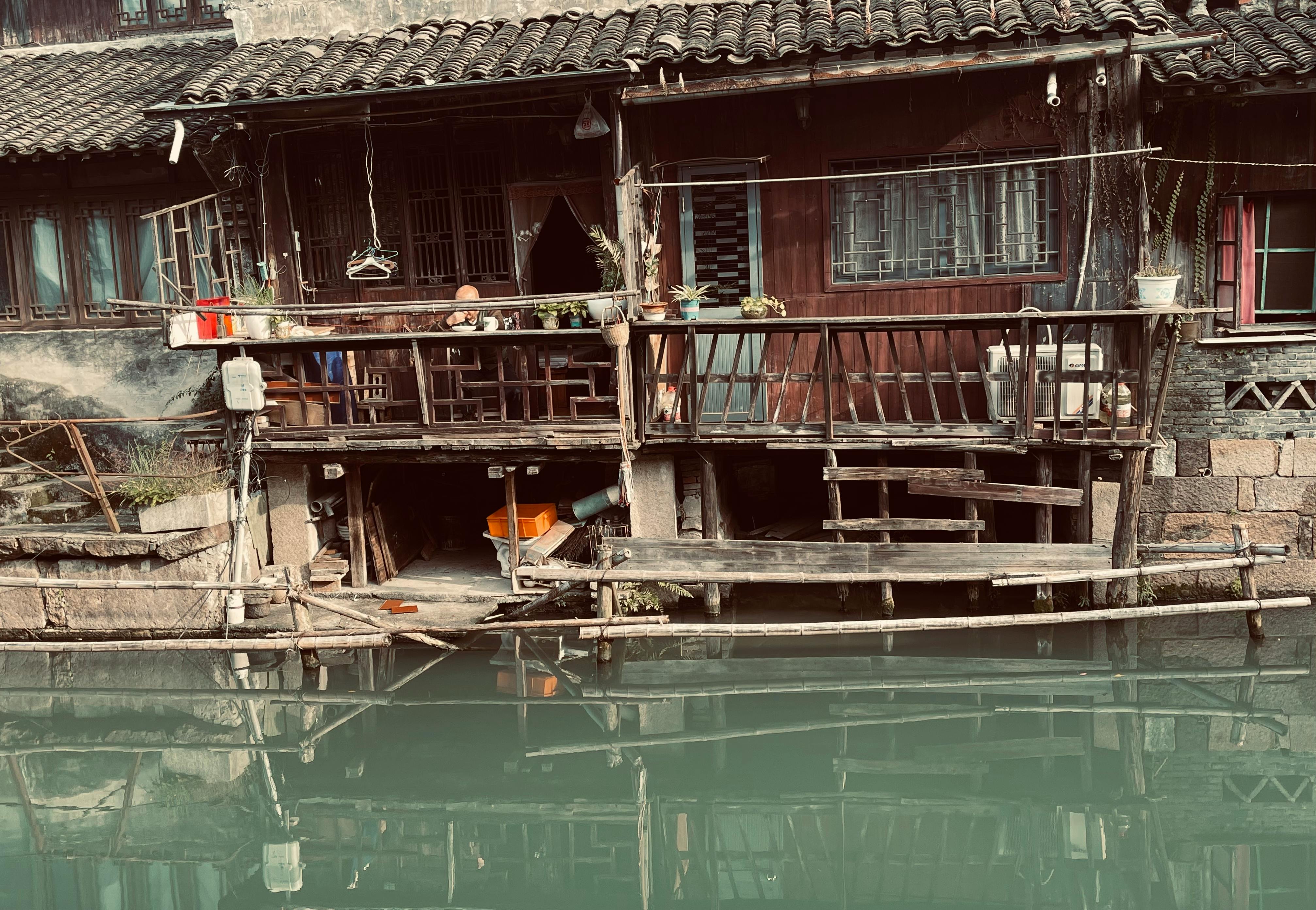 Traditional Riverside Wooden House in Tranquil Setting · Free Stock Photo