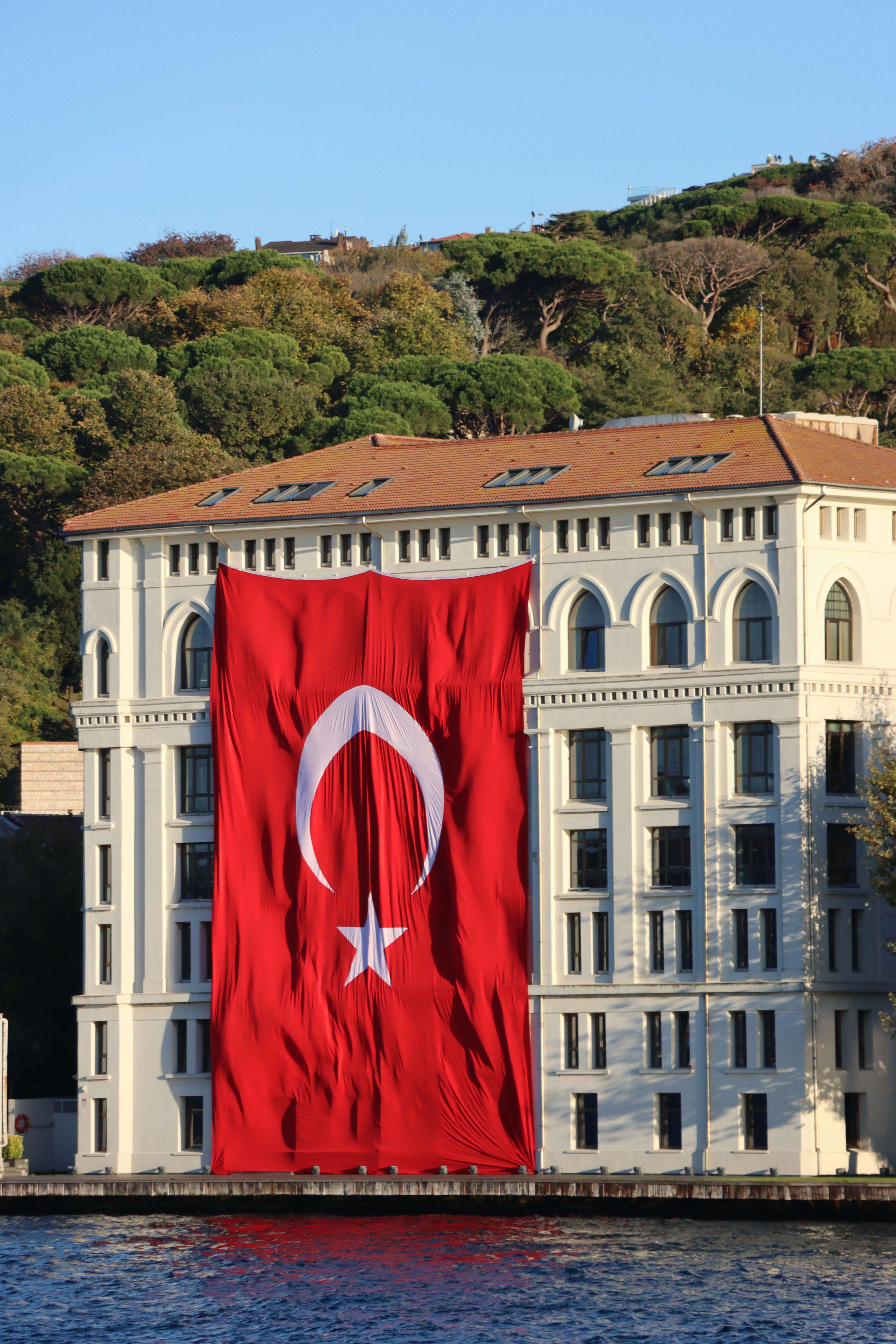 Massive Turkish Flag Draped on Historic Building · Free Stock Photo