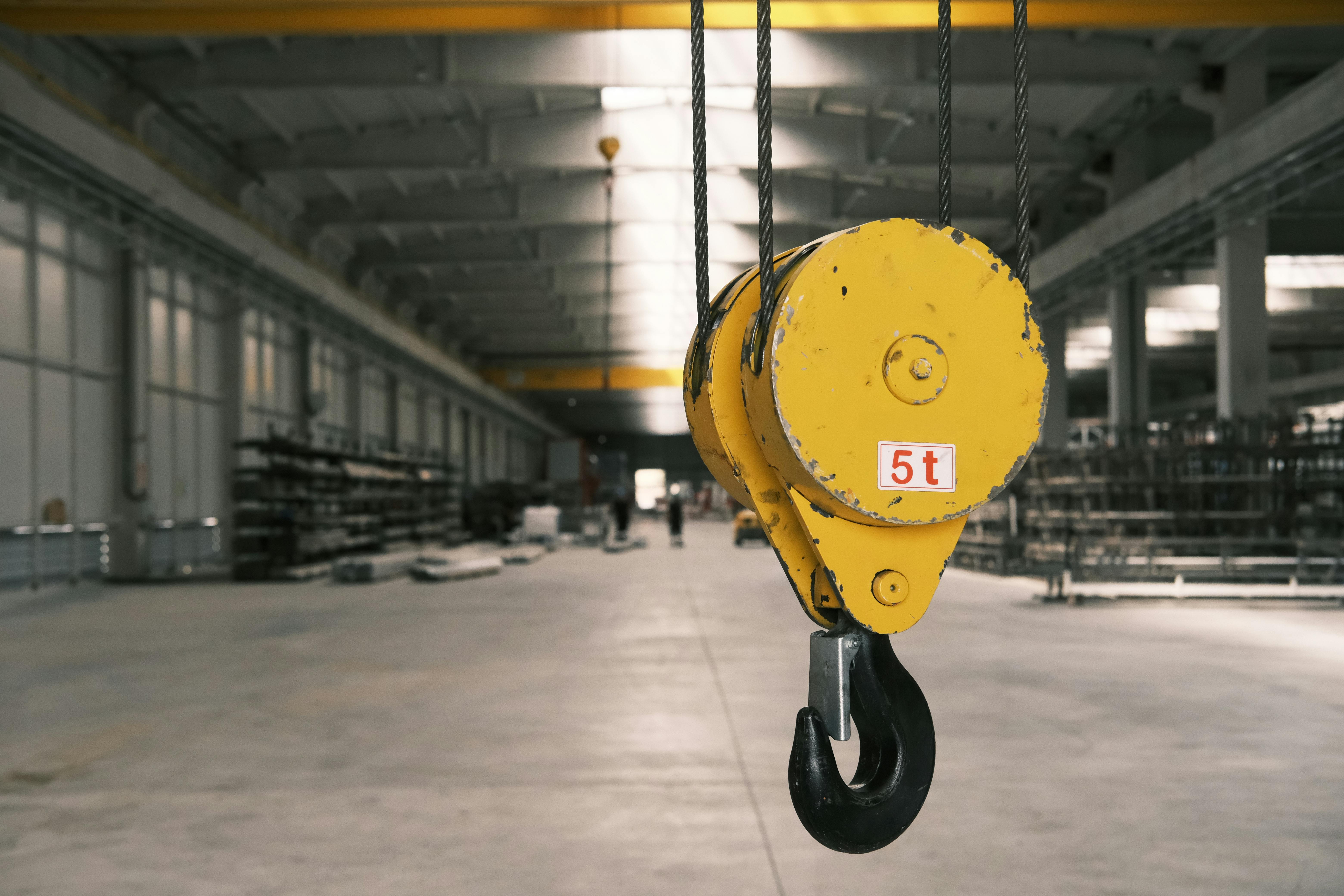 Industrial Yellow Crane Hook in Warehouse · Free Stock Photo