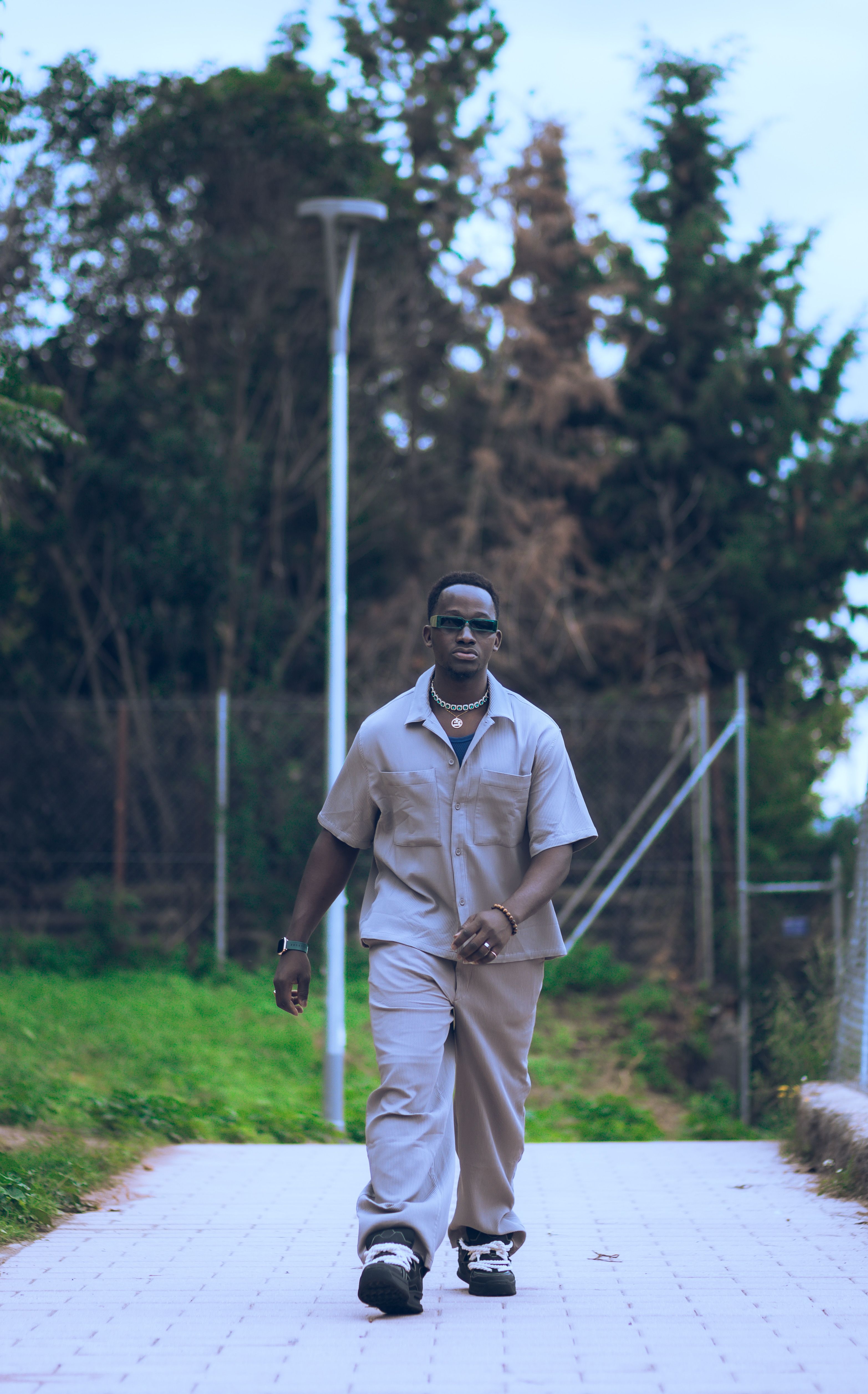 Stylish Young Man Walking in Park Pathway · Free Stock Photo