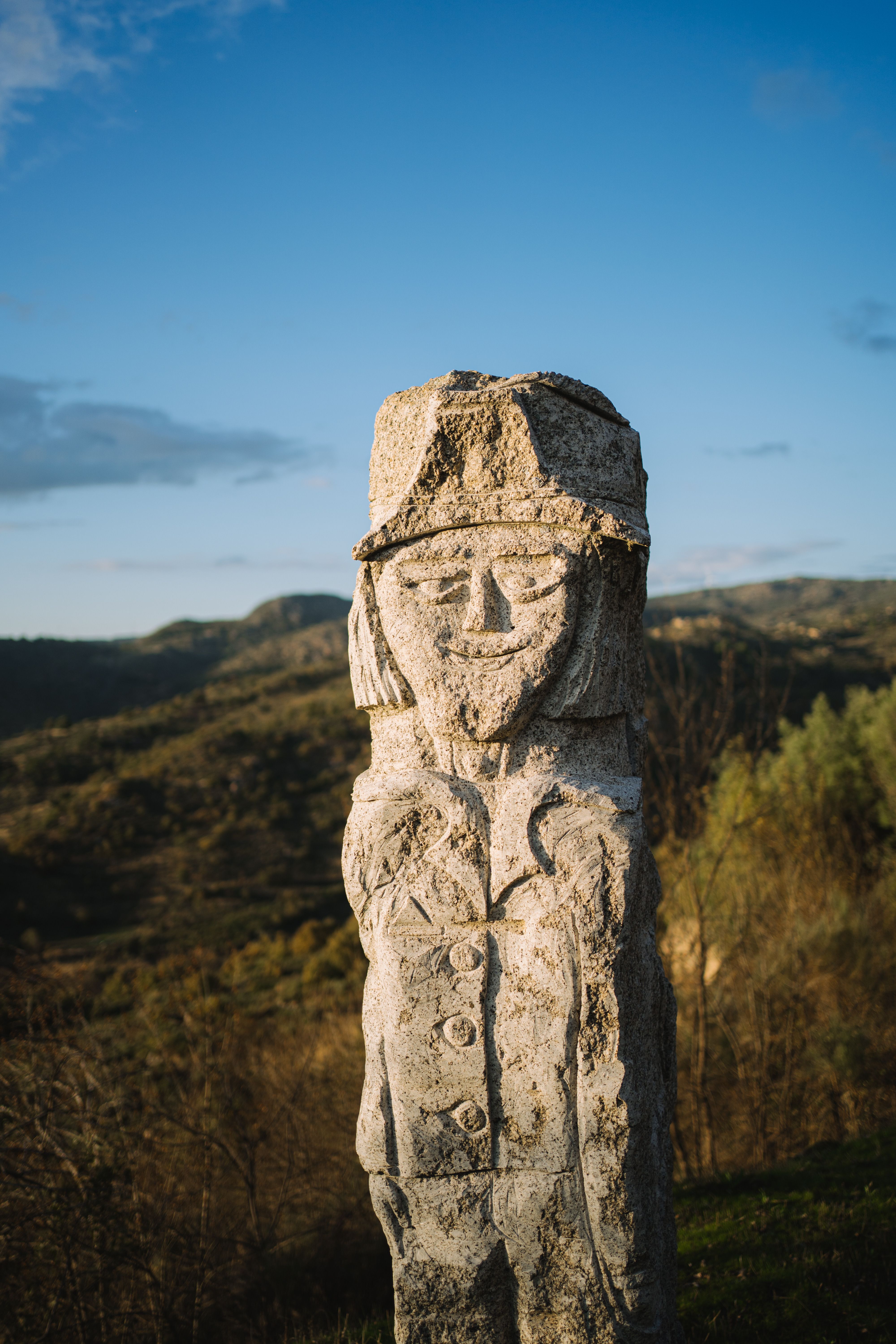 Ancient Stone Statue in Scenic Outdoor Setting · Free Stock Photo