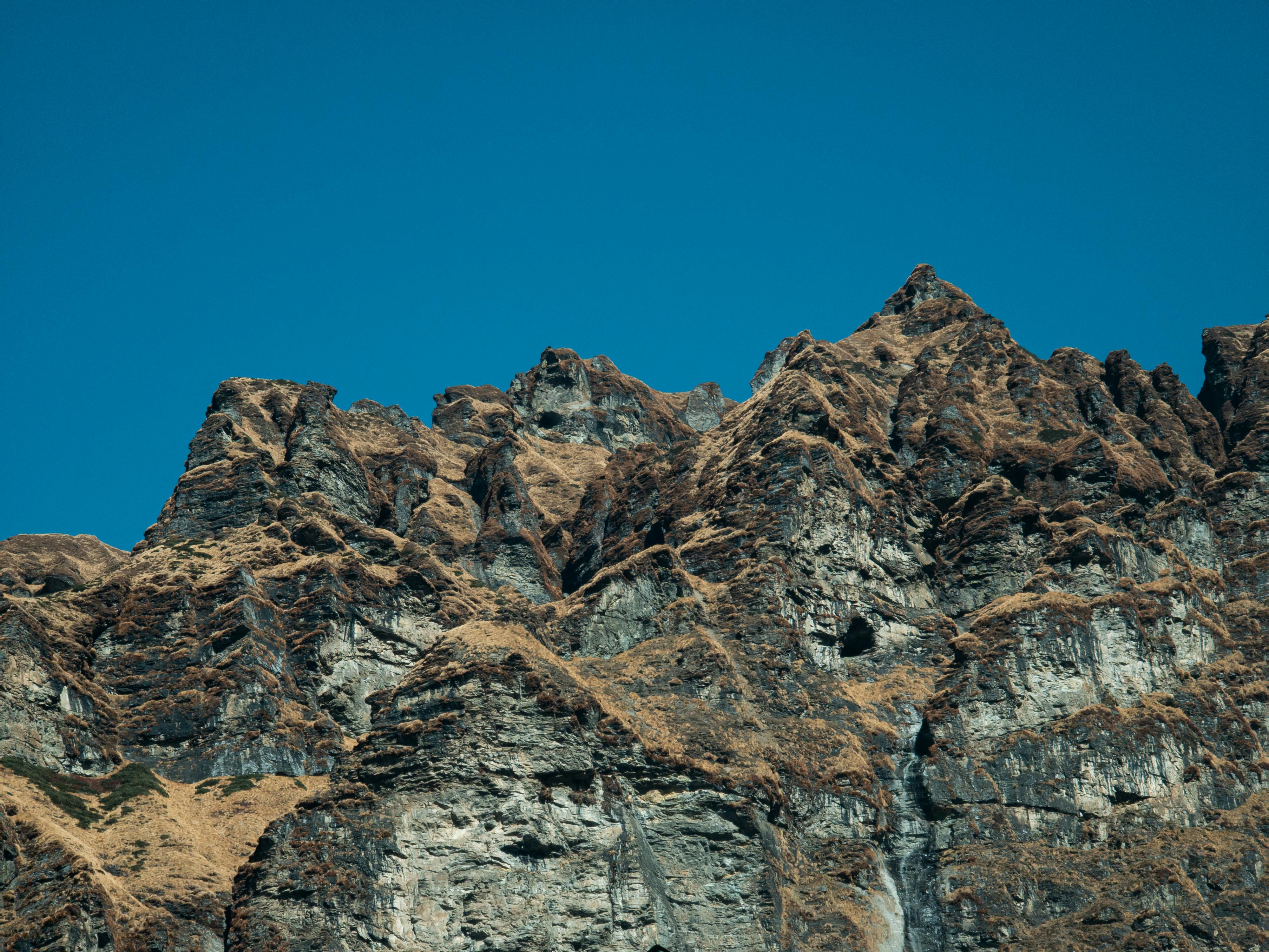 Rugged Mountain Peaks Under Clear Sky · Free Stock Photo