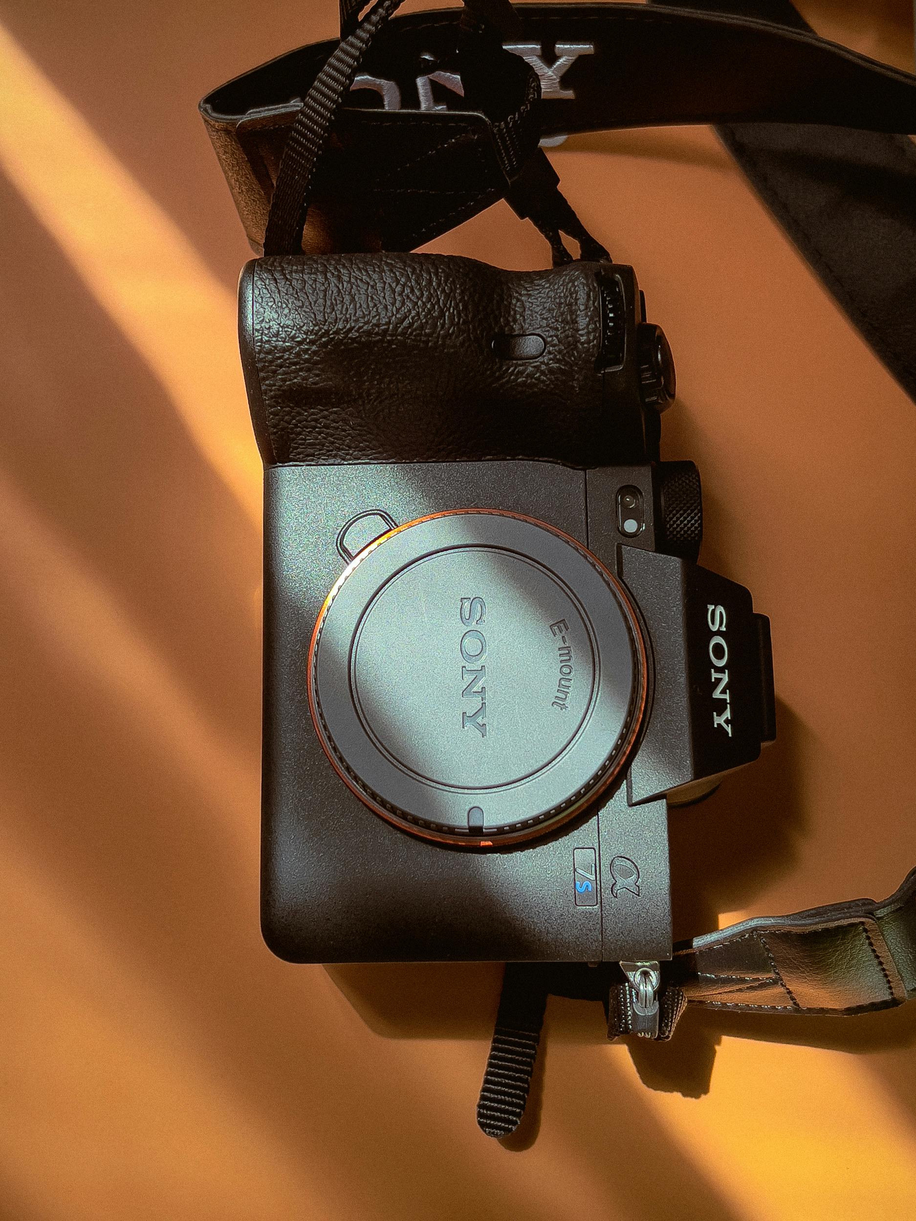 Sony Camera Body with Strap on Solid Surface · Free Stock Photo