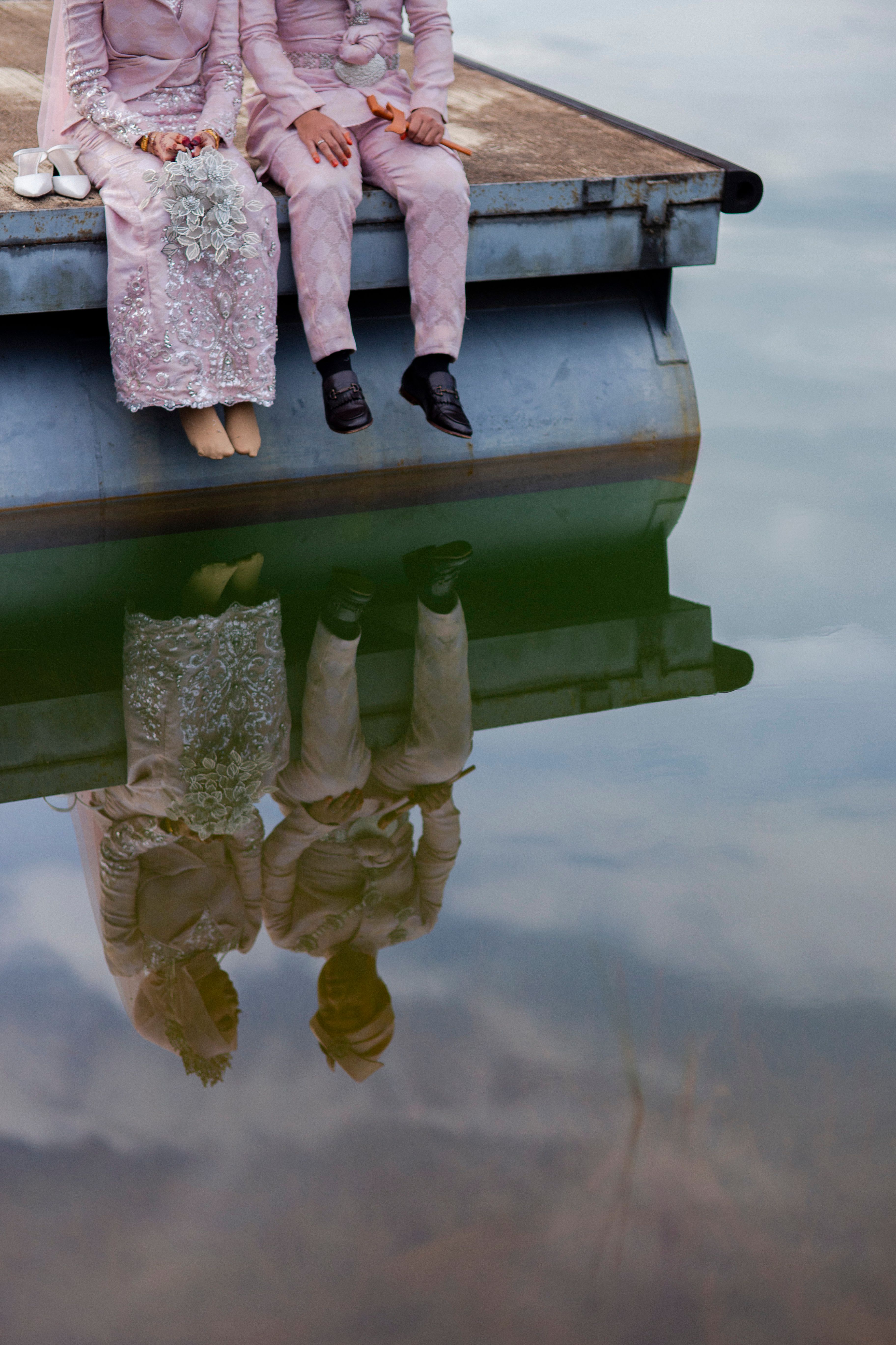 Elegant Wedding Couple's Reflection on Water · Free Stock Photo