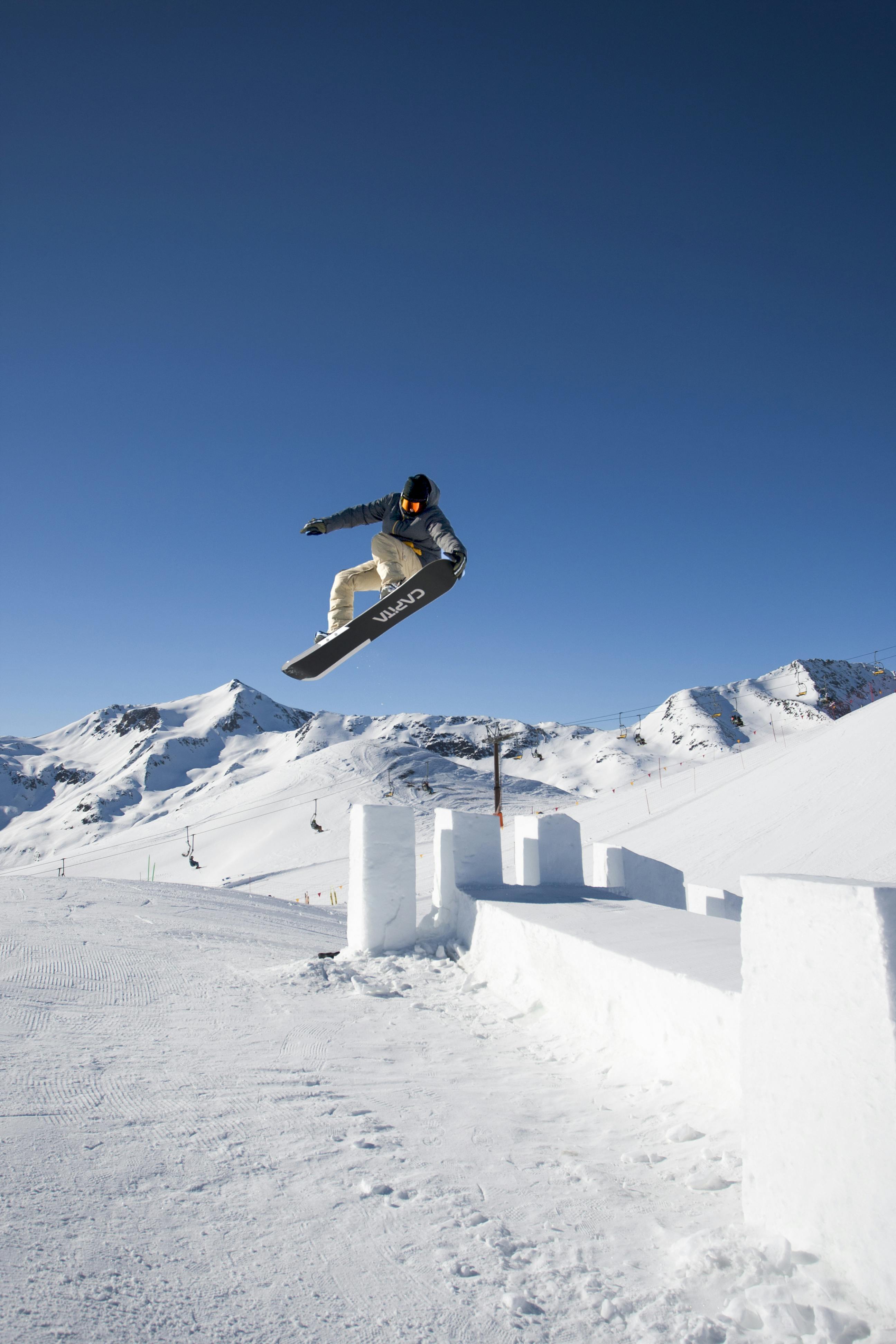 Snowboarder Leaping in Livigno Snowpark · Free Stock Photo