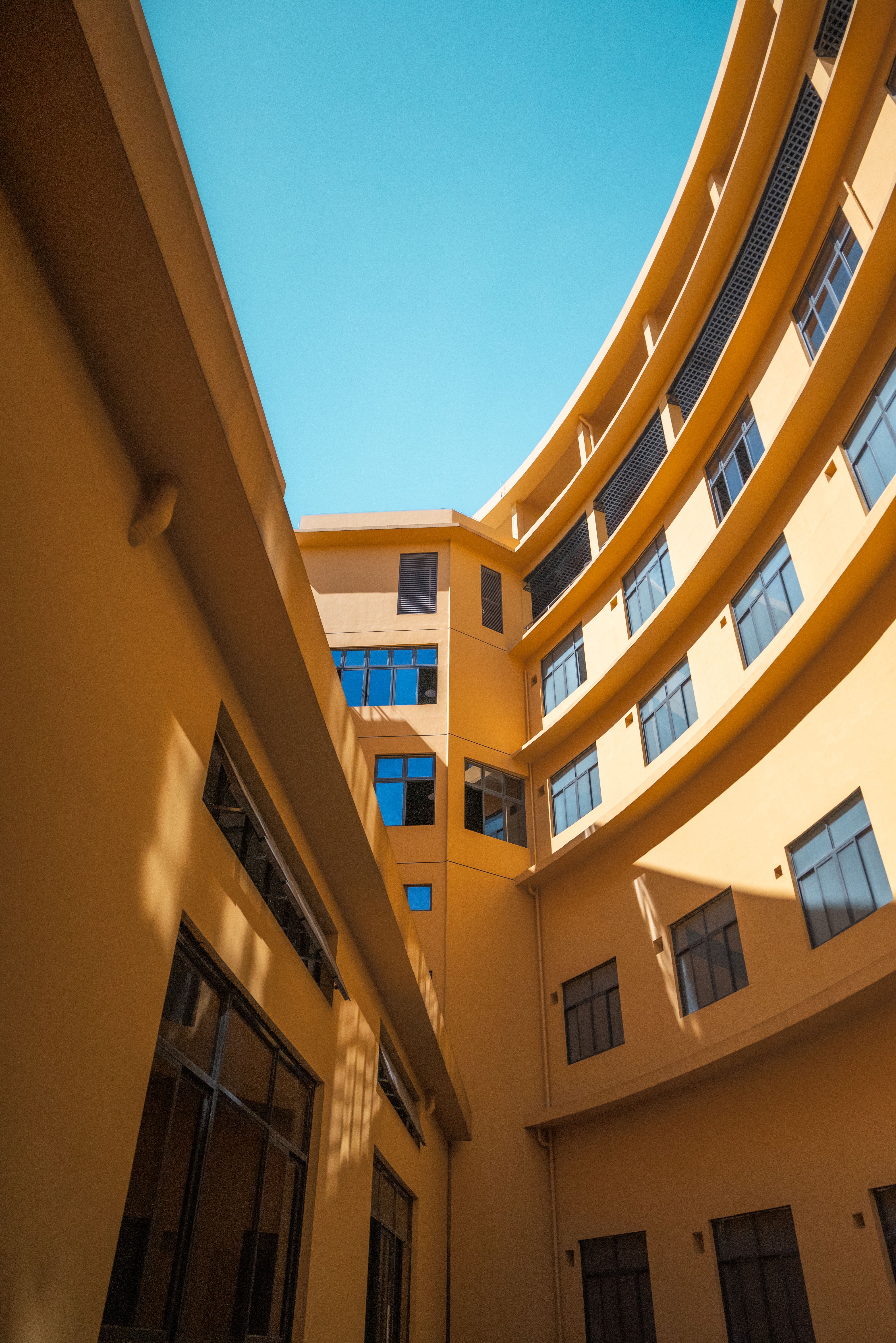 Curved Modern Building with Yellow Facade · Free Stock Photo
