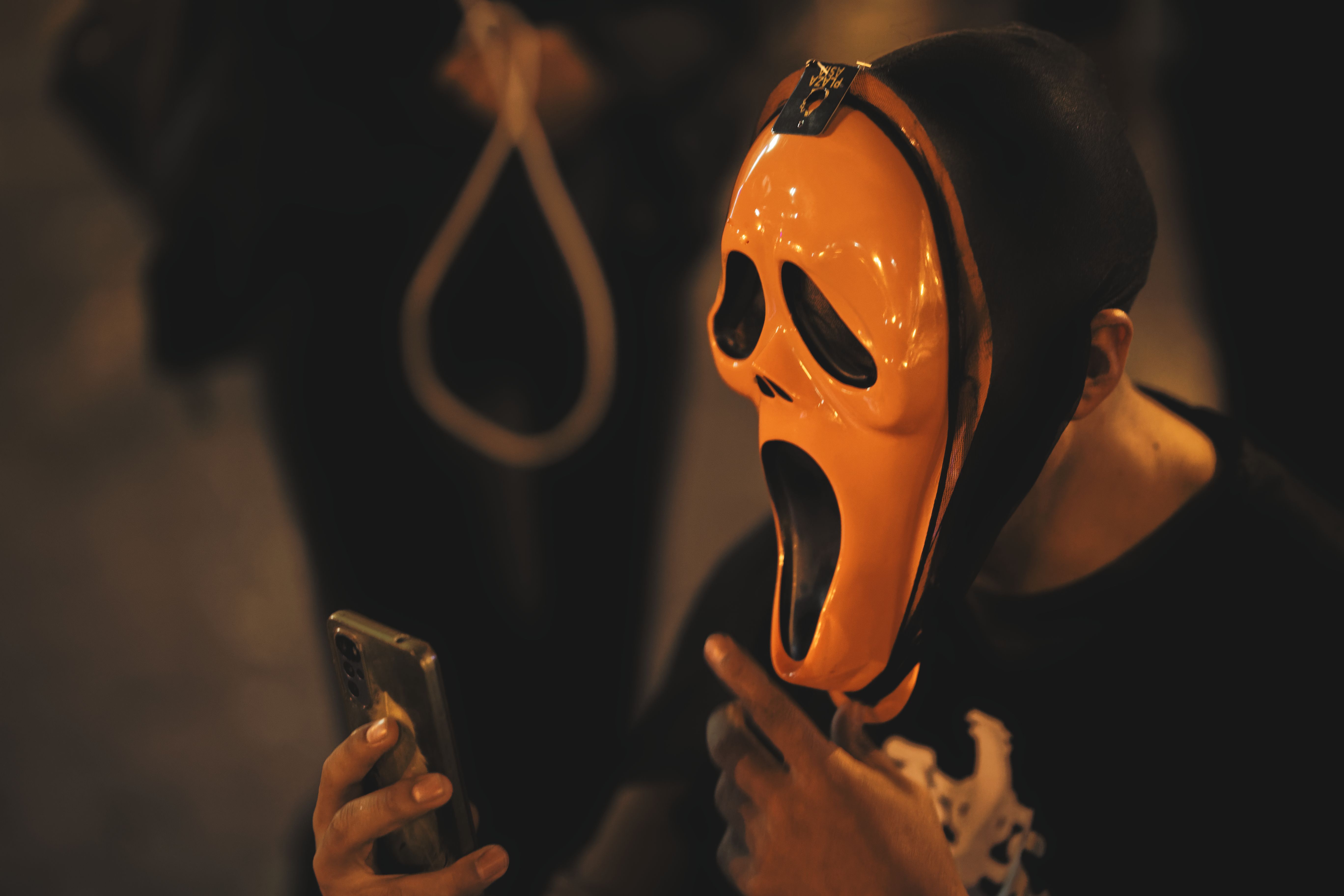 Masked Individual Checking Phone in Arequipa · Free Stock Photo