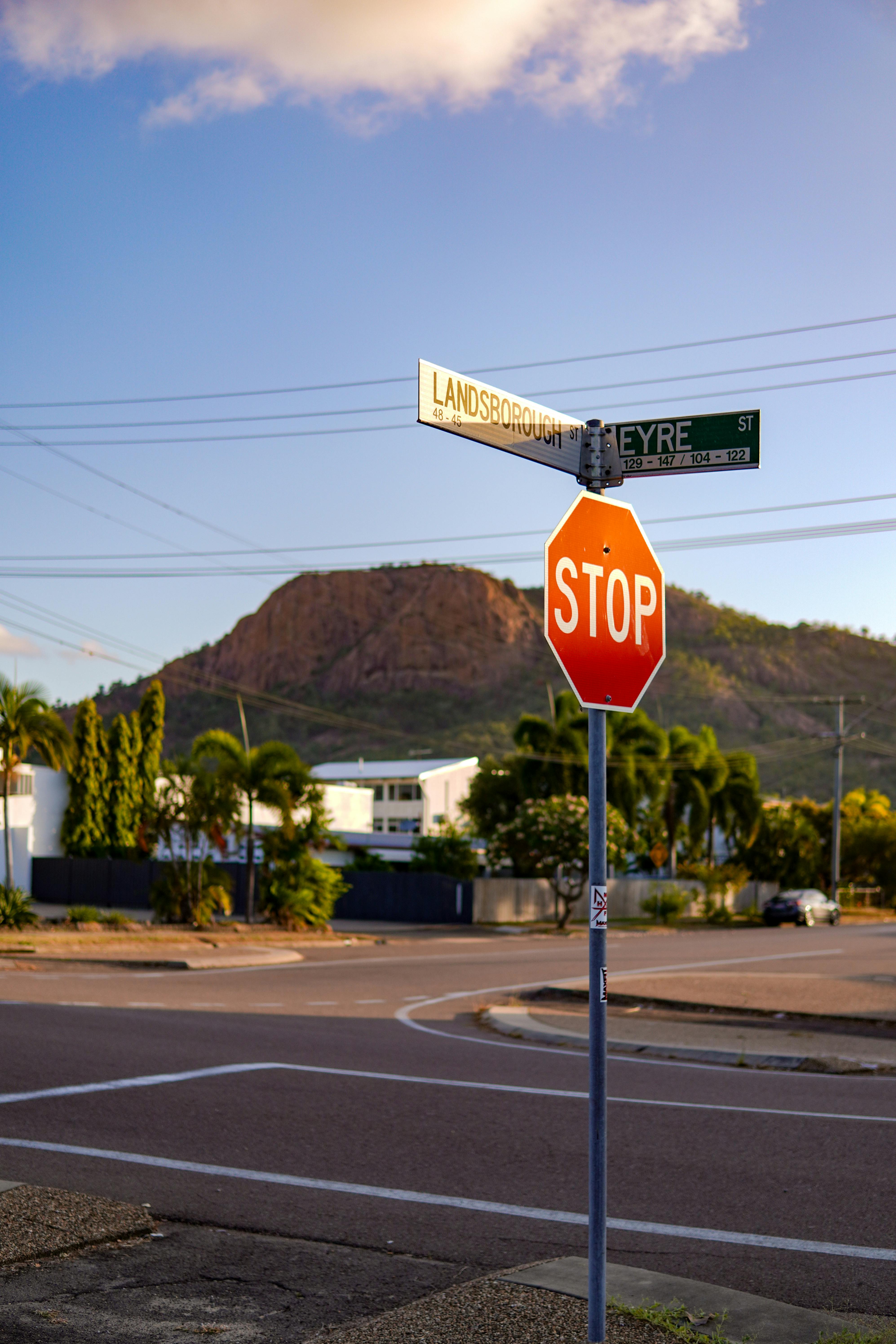 Stop Sign with Mountain Background at Sunset · Free Stock Photo