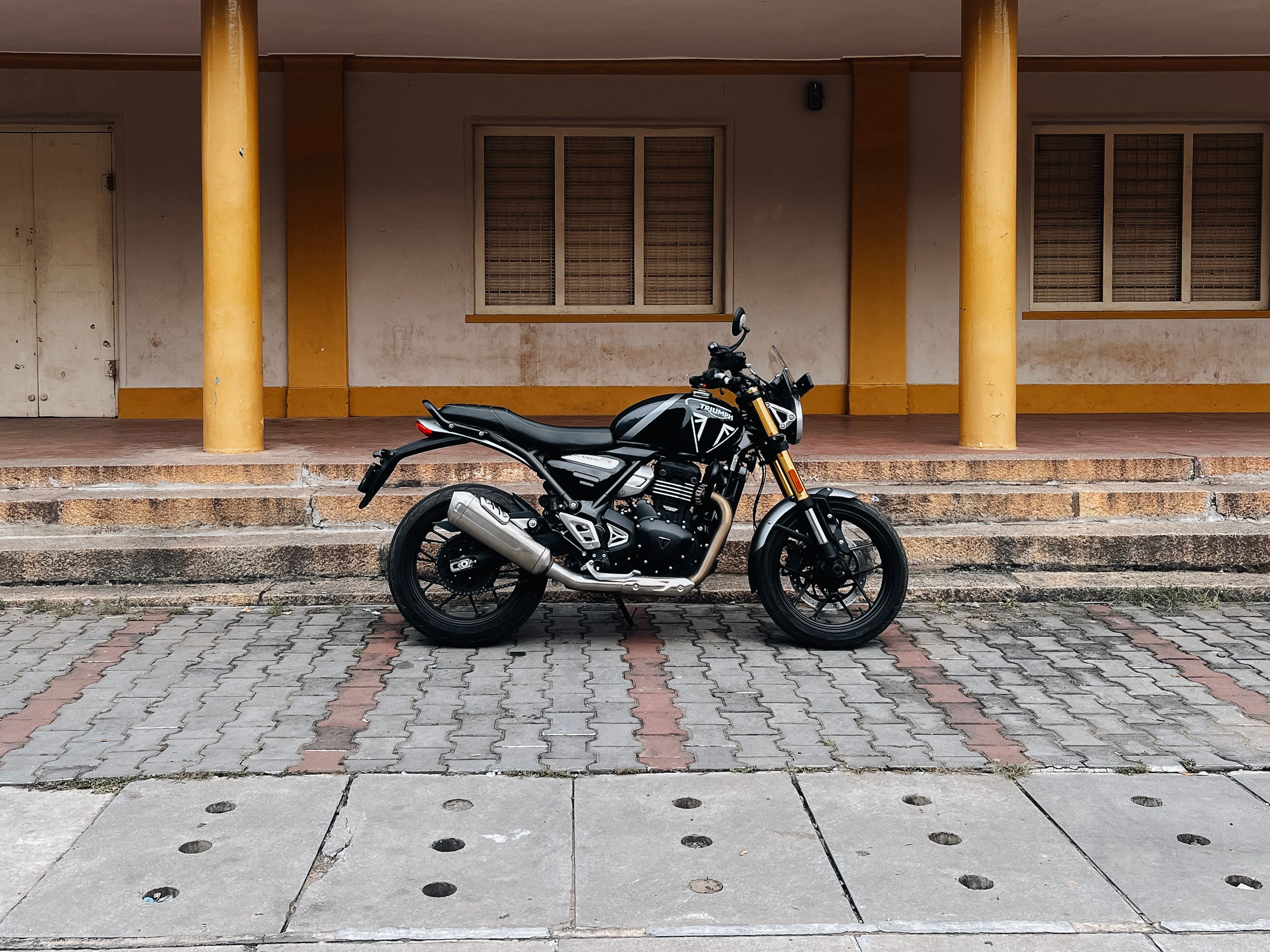 Street Motorcycle Against Yellow Building Exterior · Free Stock Photo