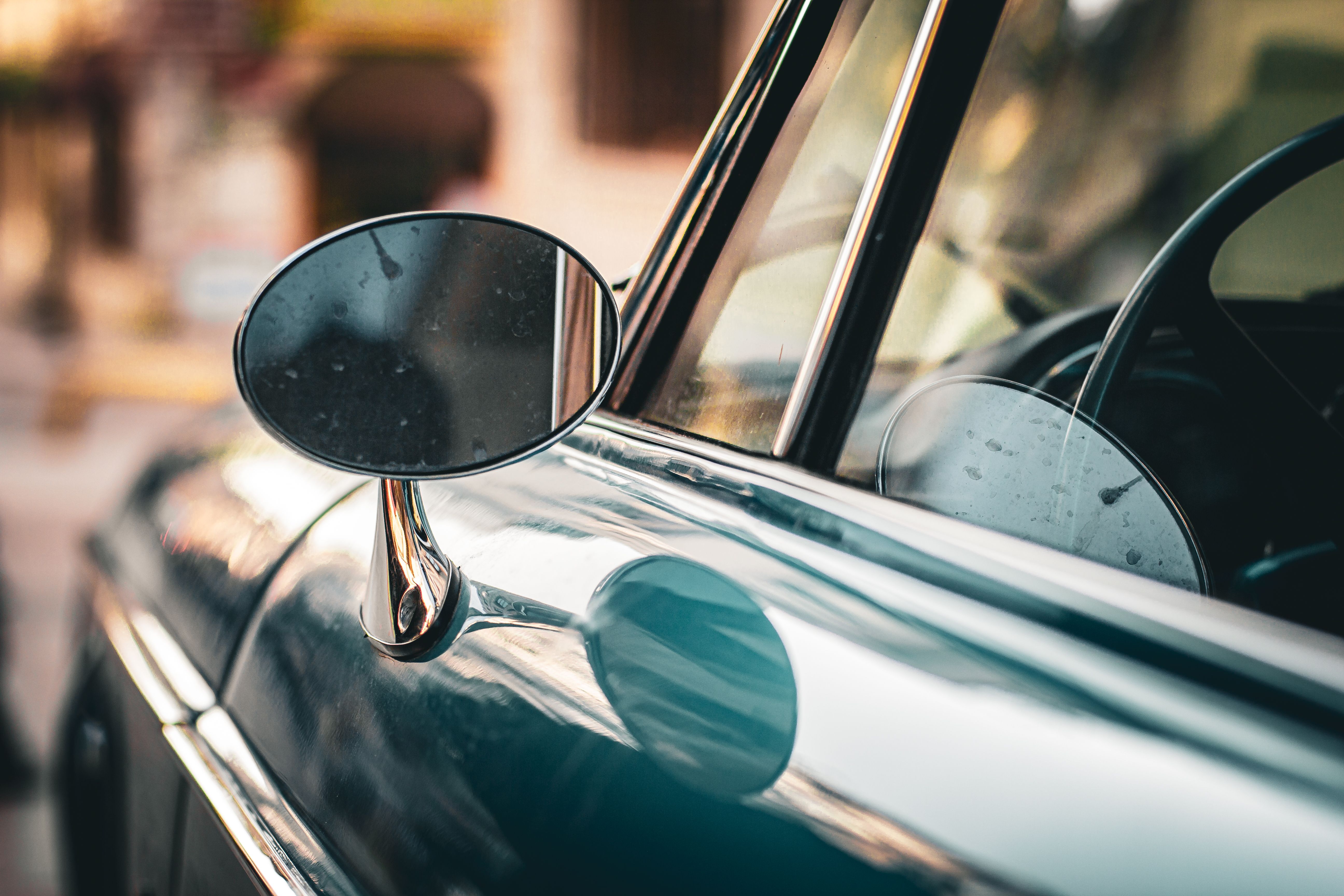 Close-up of a Vintage Car Mirror in Golden Light · Free Stock Photo