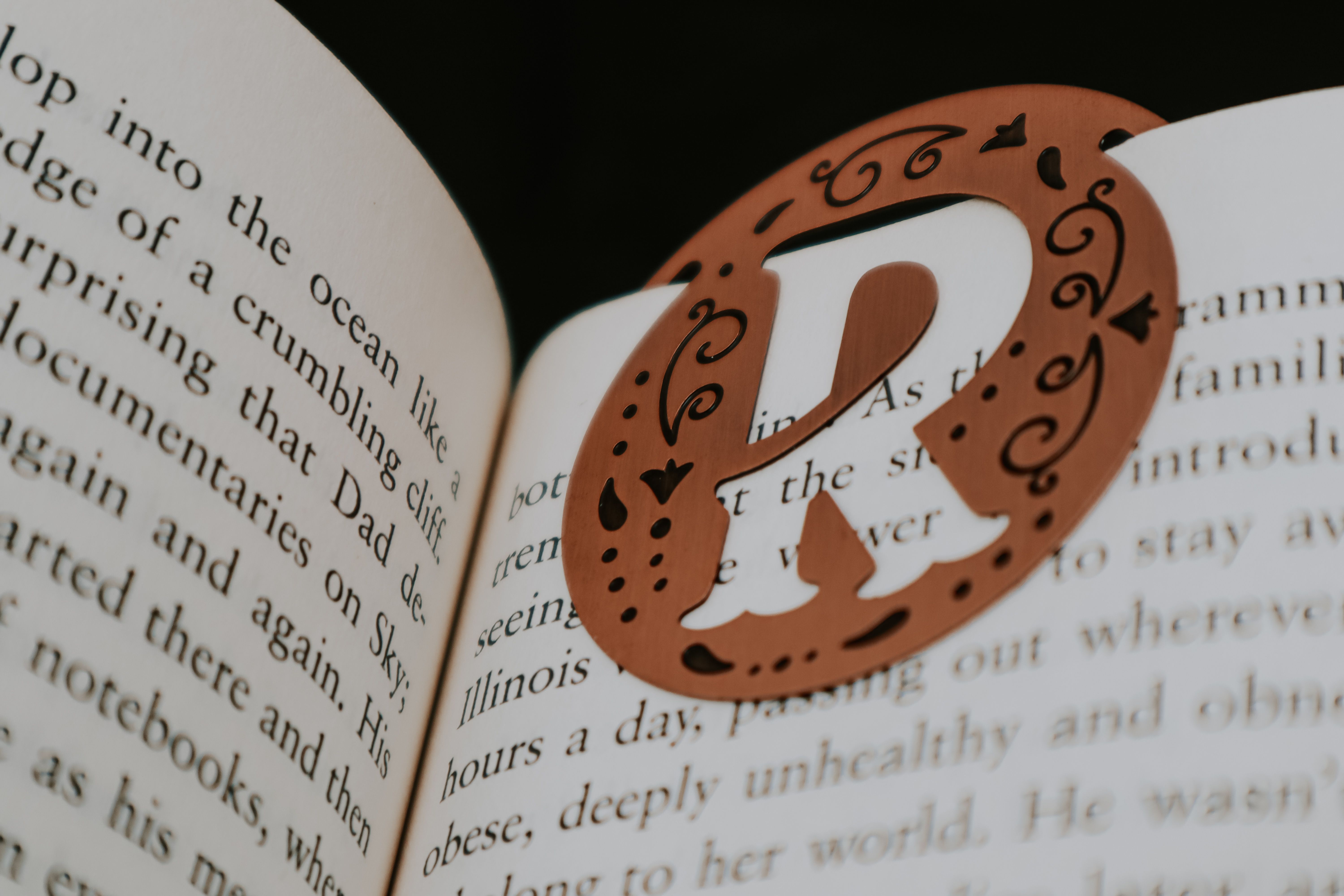 Artistic Bookmark on Open Book Pages Close-Up · Free Stock Photo