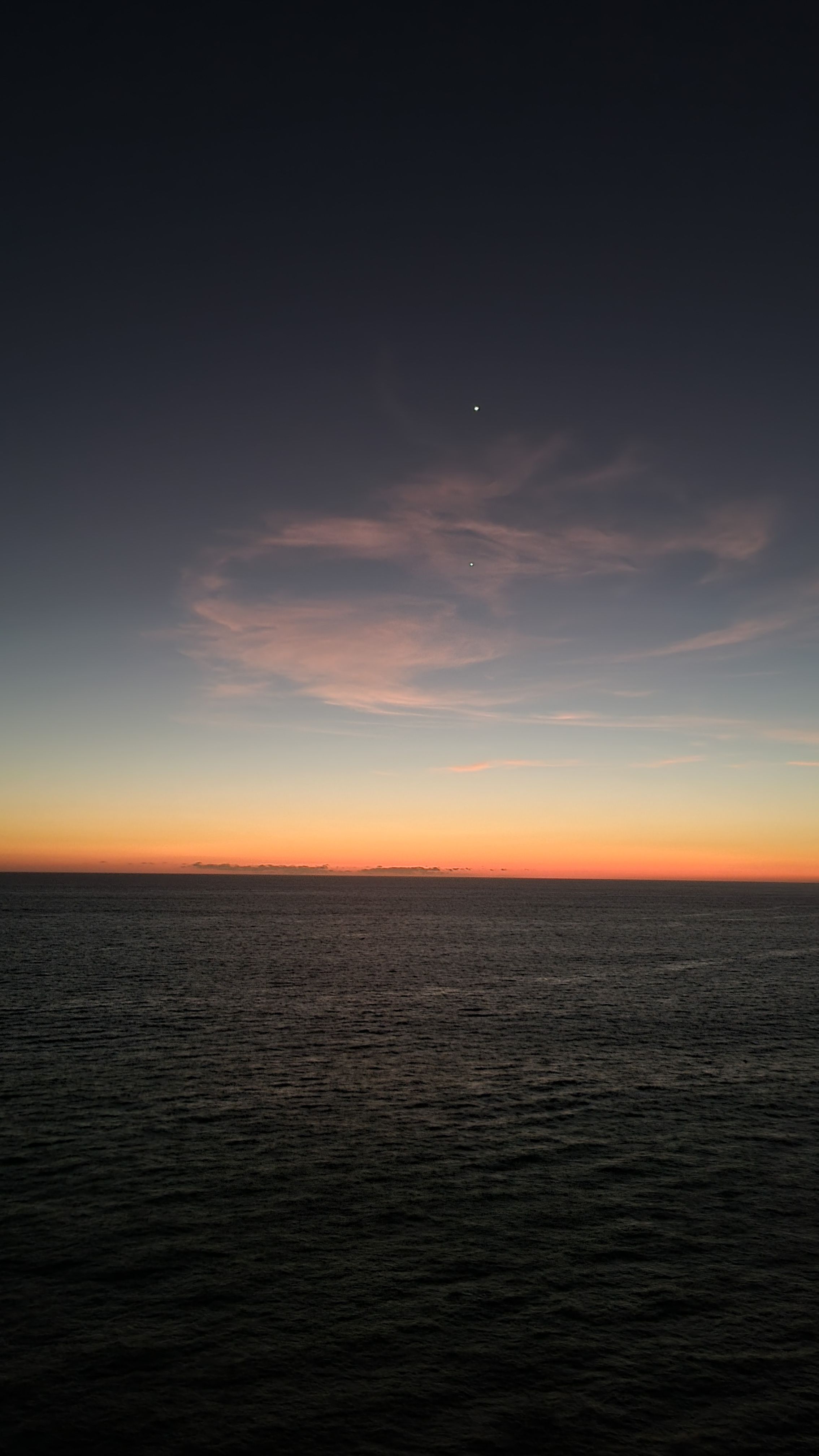 Serene Ocean Sunset with Stars Visible in Twilight · Free Stock Photo