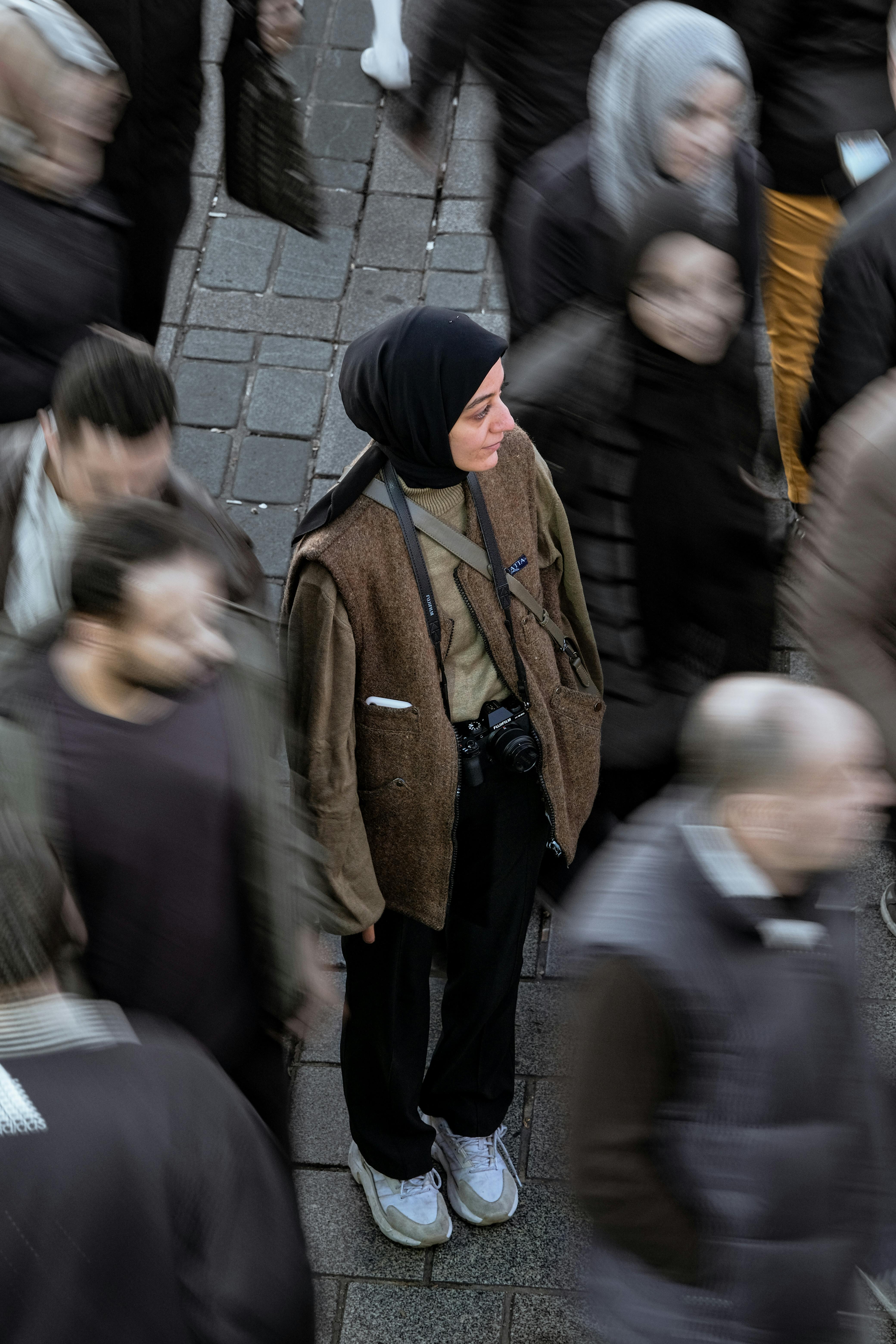 Woman Standing Still in a Busy Crowd · Free Stock Photo