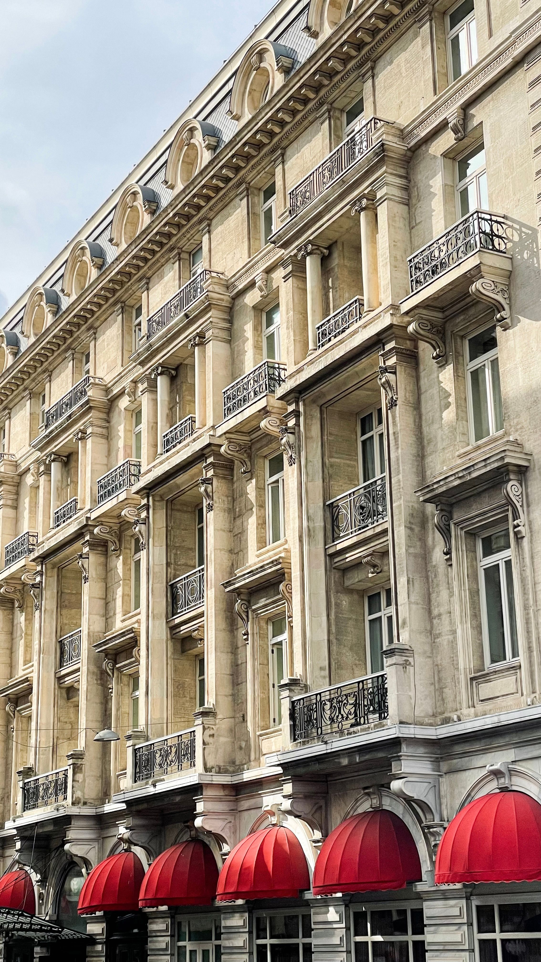 Classic European Building with Red Awnings · Free Stock Photo