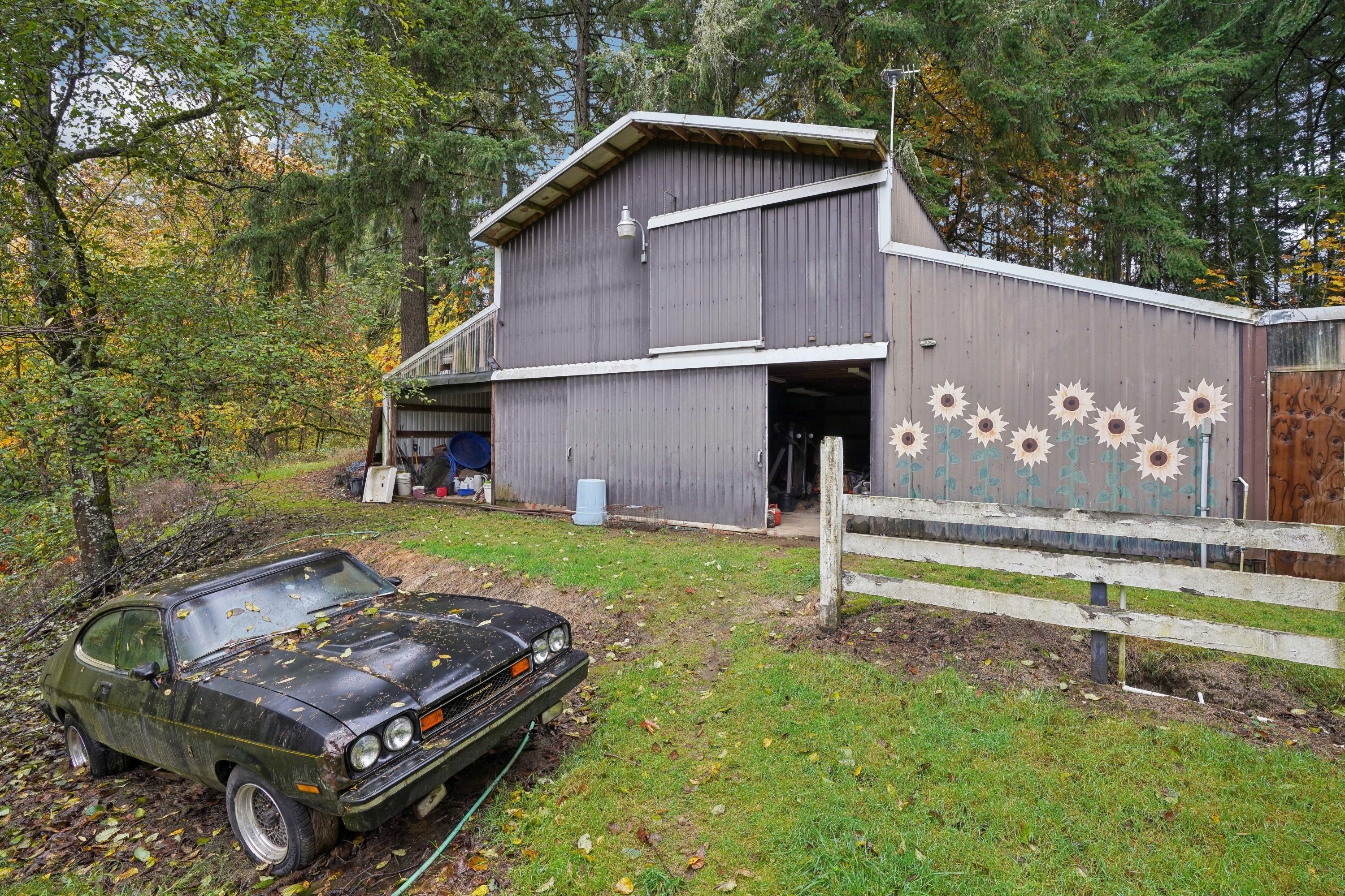 Vintage Car Beside Rustic Barn in Autumn Setting · Free Stock Photo