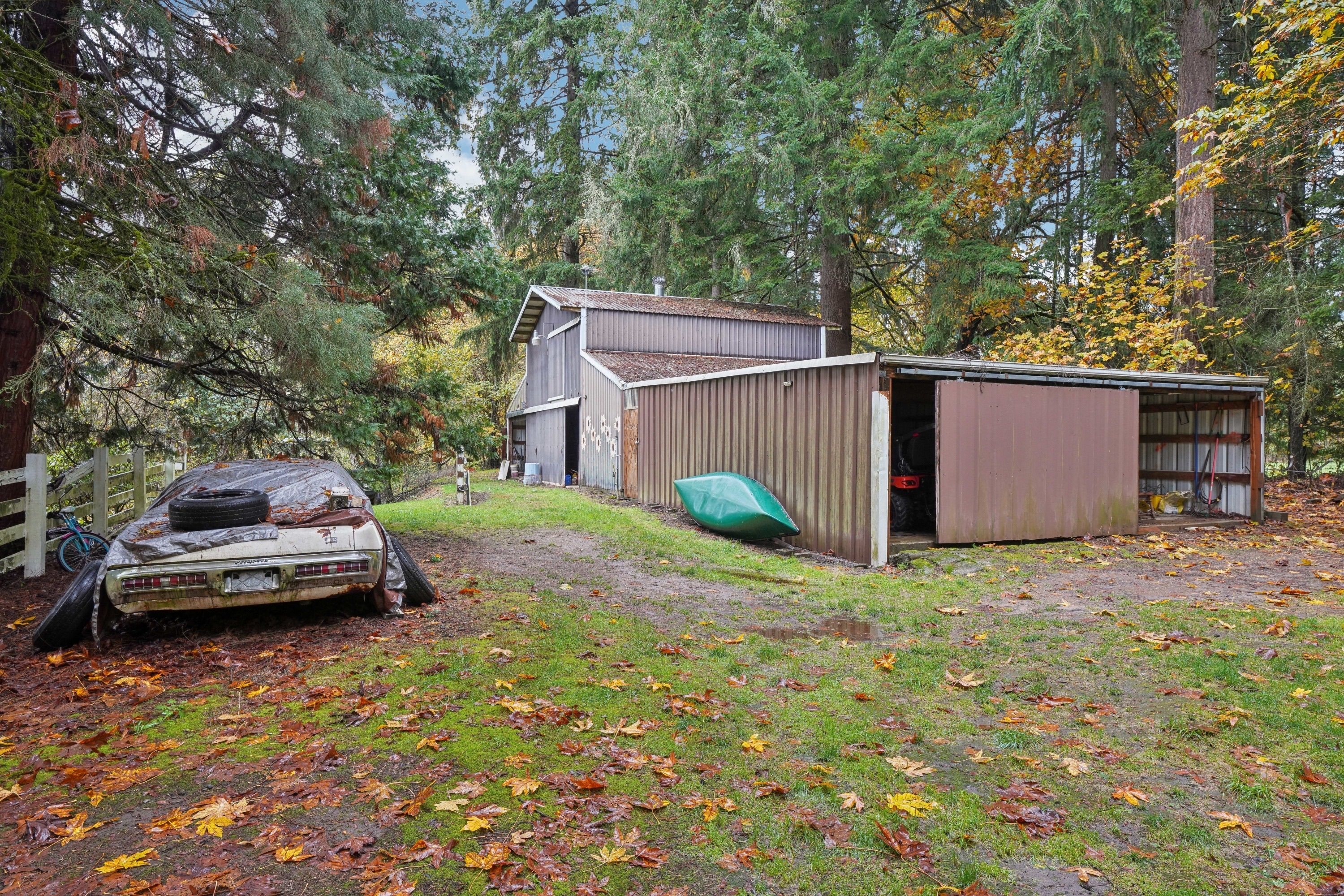 Rustic Barn with Vintage Car in Forest Setting · Free Stock Photo