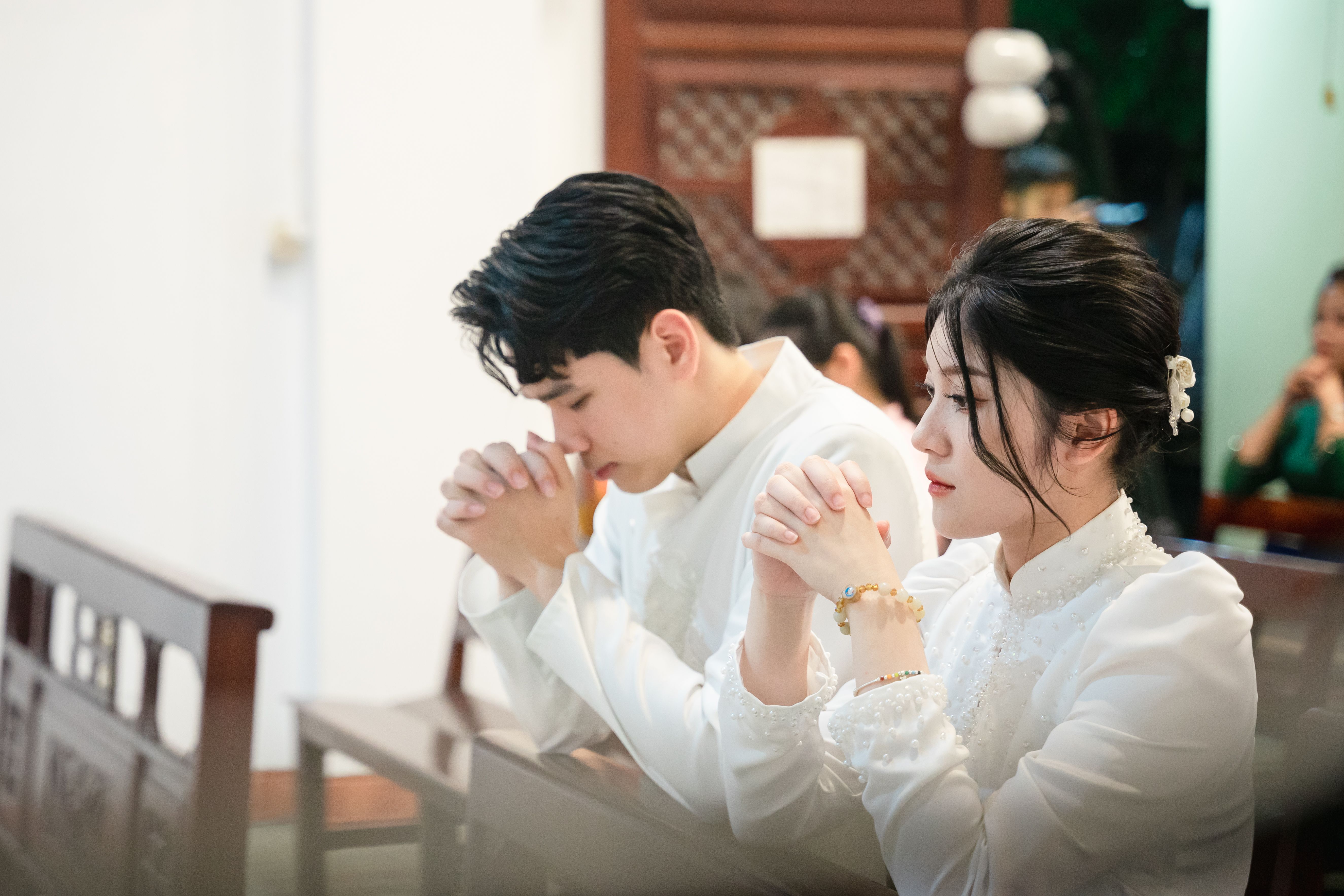 Young Couple Praying in a Peaceful Church Setting · Free Stock Photo