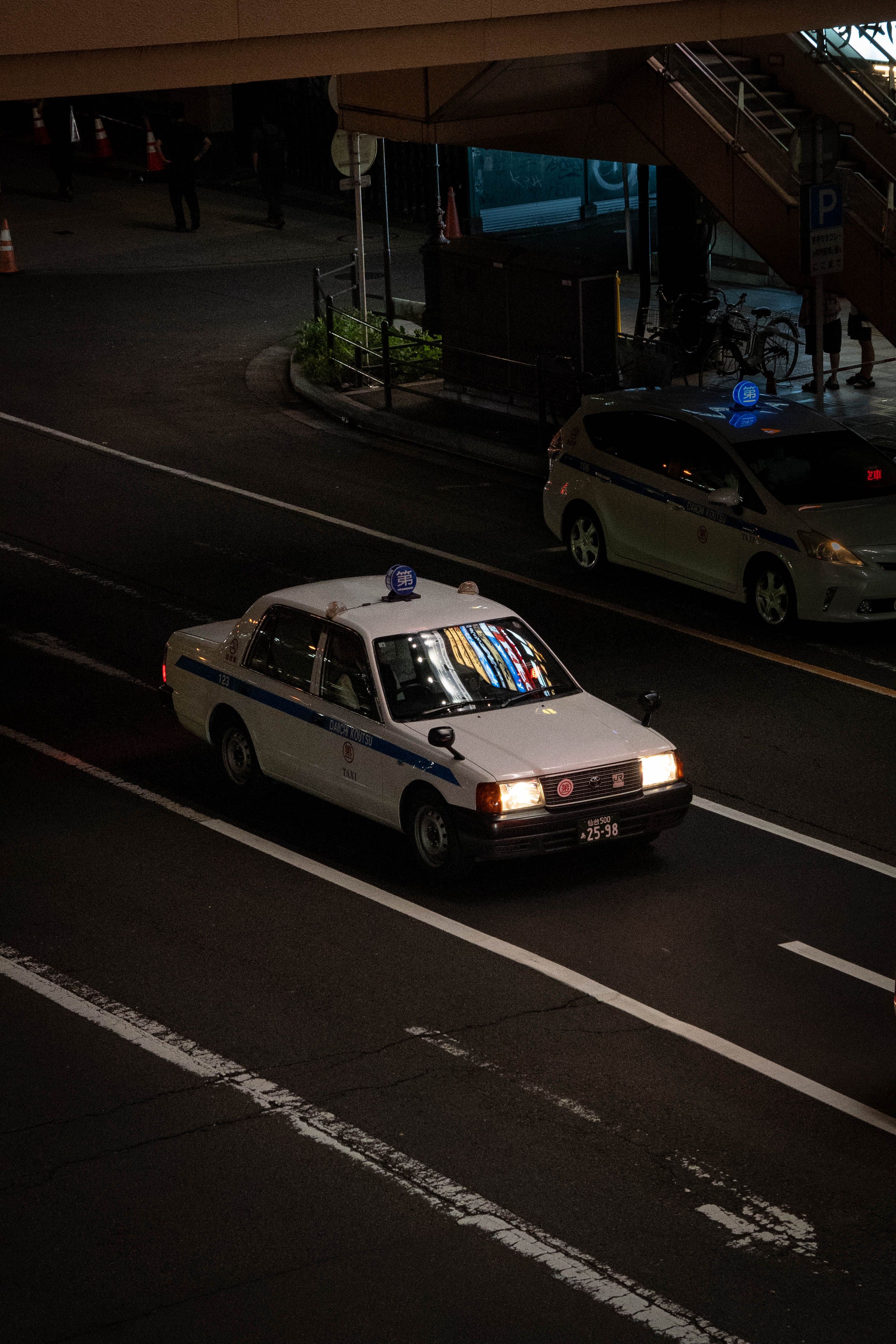 Nighttime Taxi on Urban Street Crossing at Night · Free Stock Photo