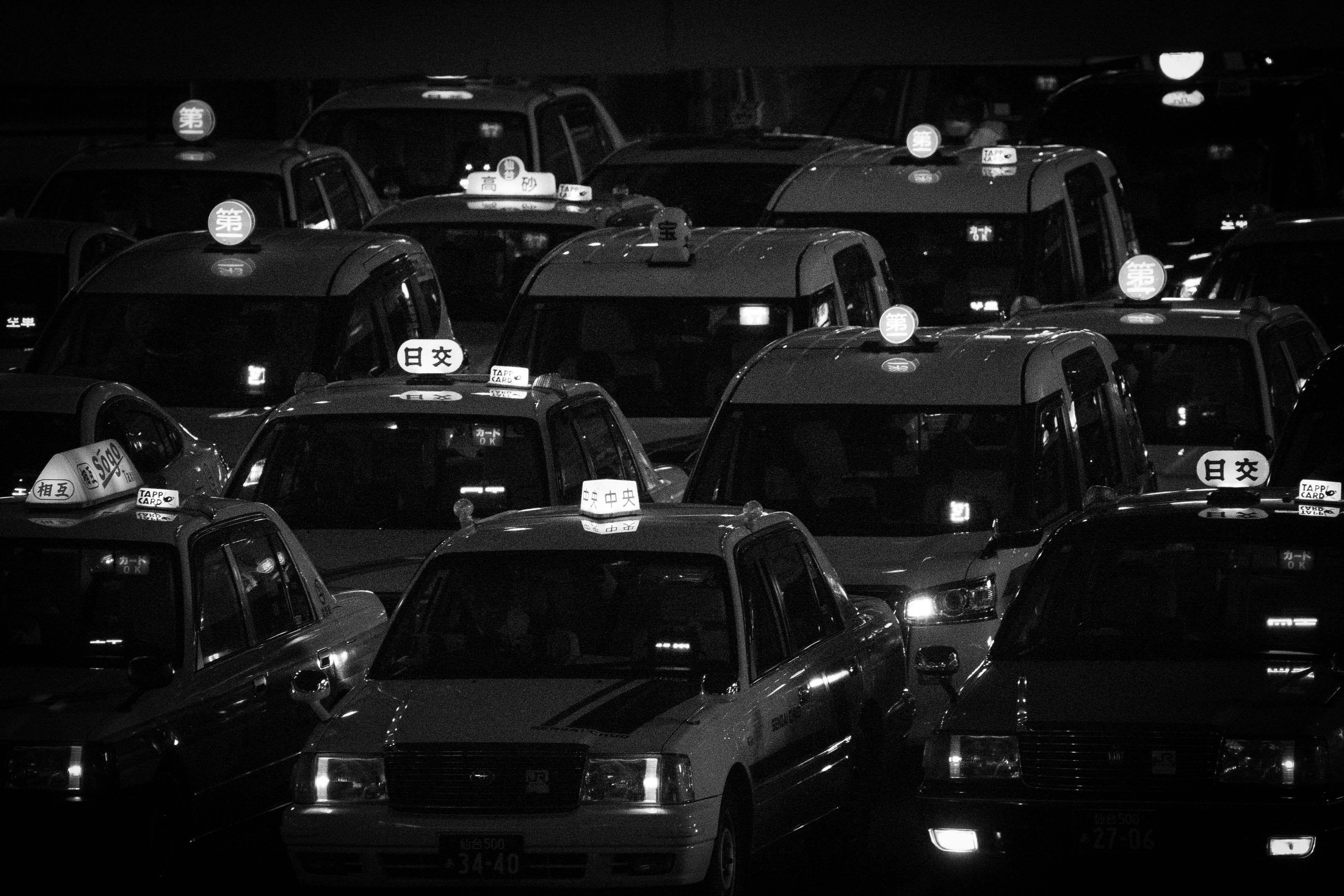 Black and White Taxi Traffic in Urban Night Scene · Free Stock Photo