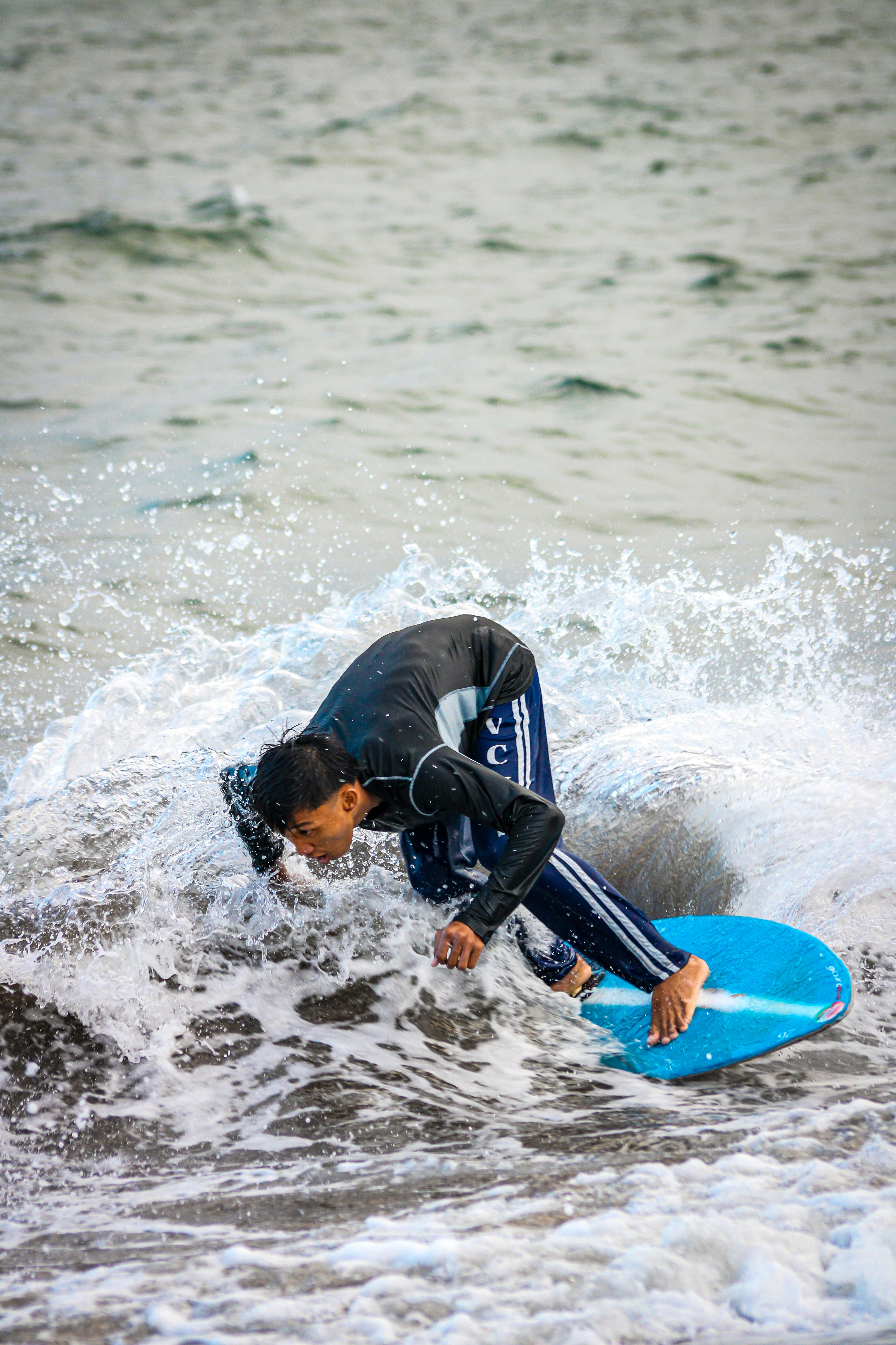 Dynamic Surfing Action on Ocean Waves · Free Stock Photo