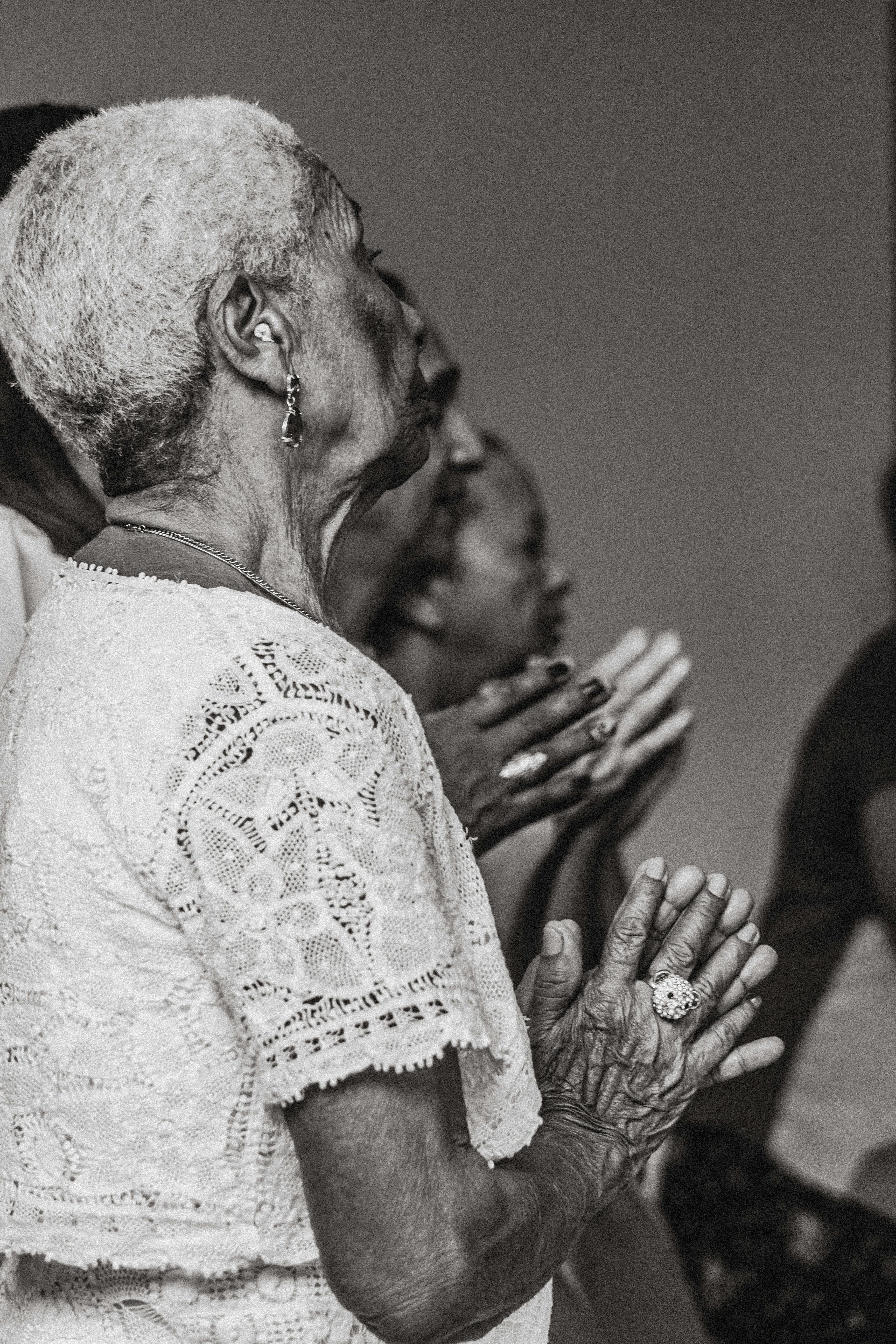 Elderly Woman Clapping in Black and White Gathering · Free Stock Photo